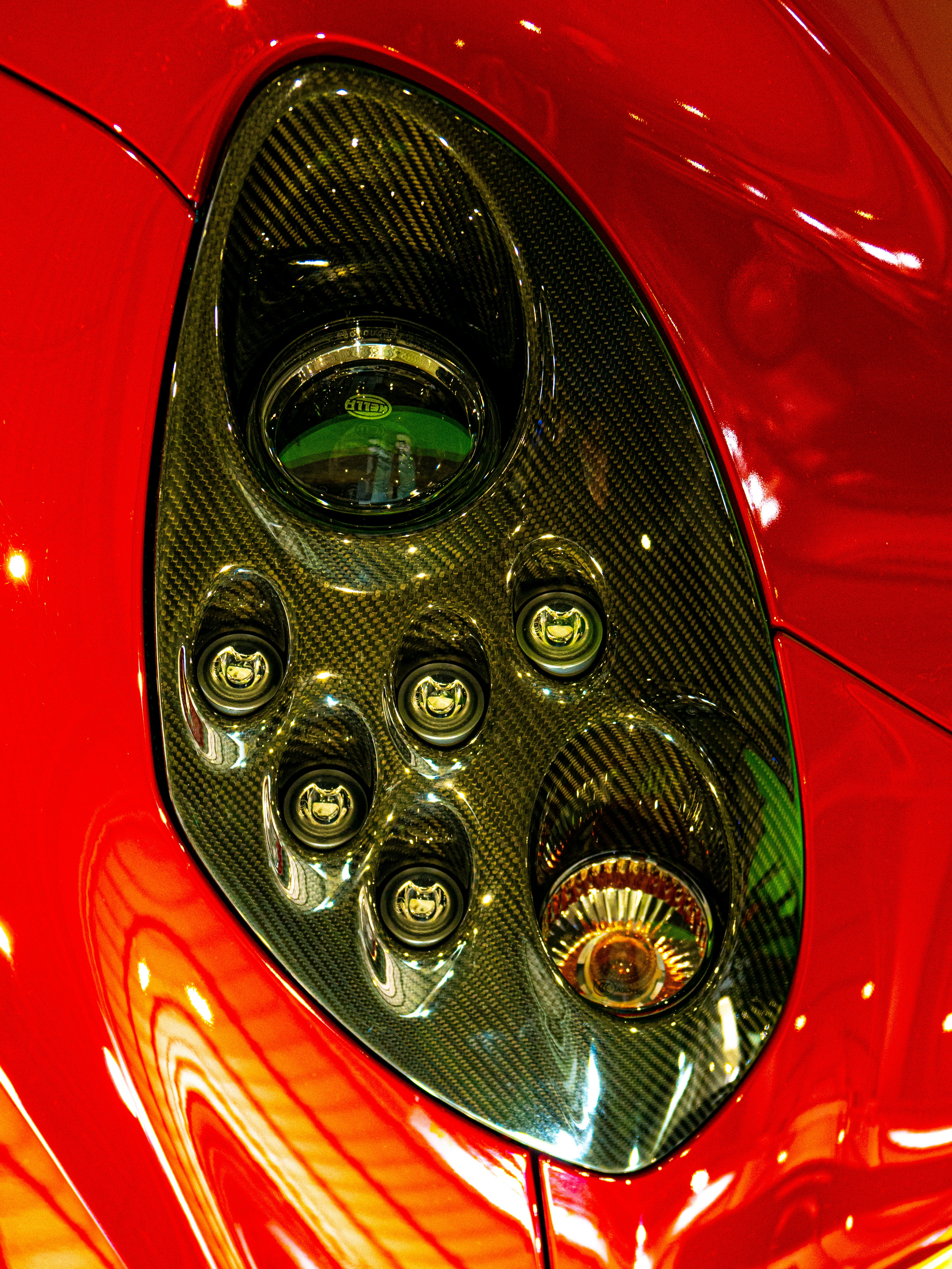 Scarlet Headlight Sculpture: Carbon-Fiber Precision on a Red Hypercar