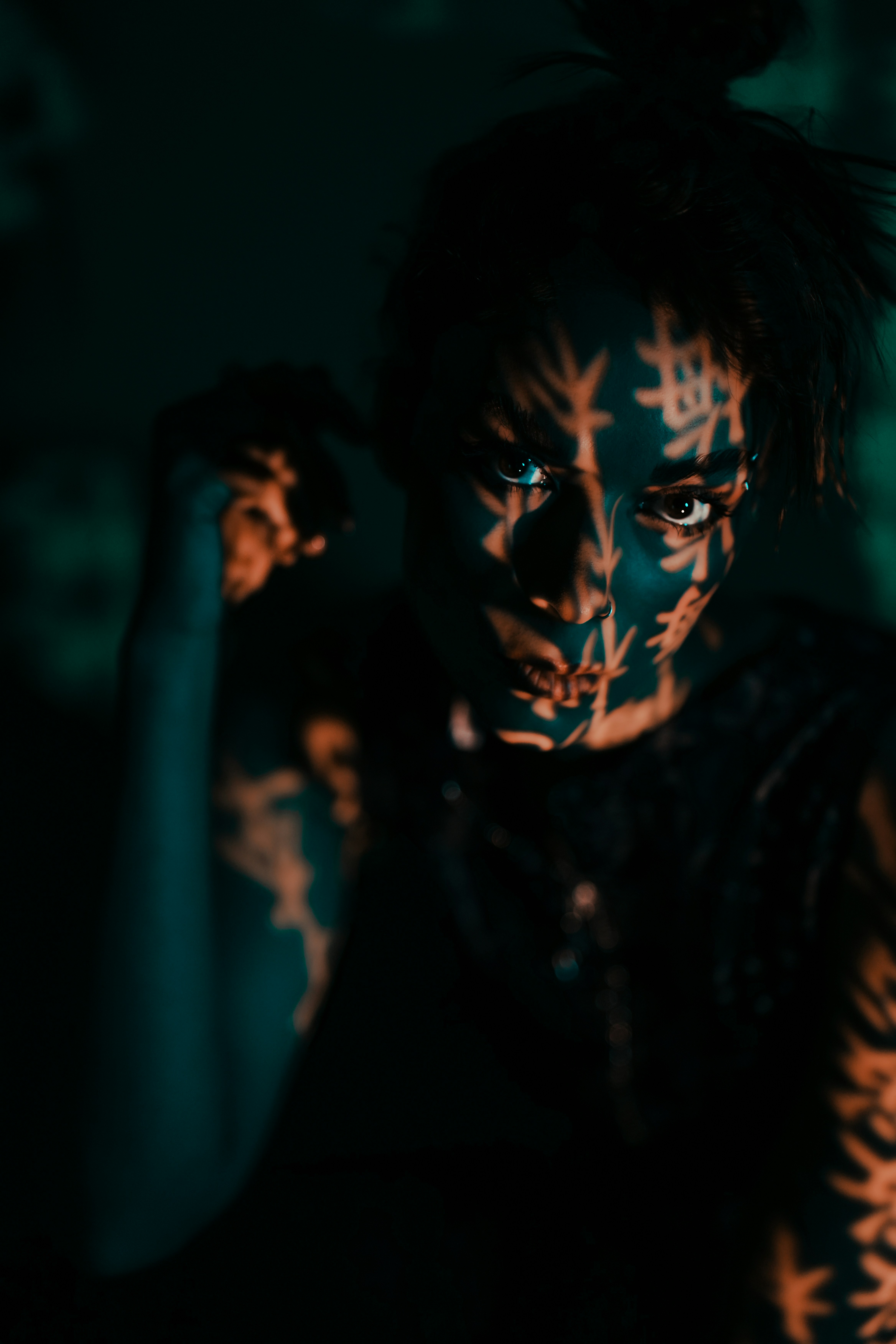 Woman poses with bold face paint and lighting. photo – Free Woman Image ...