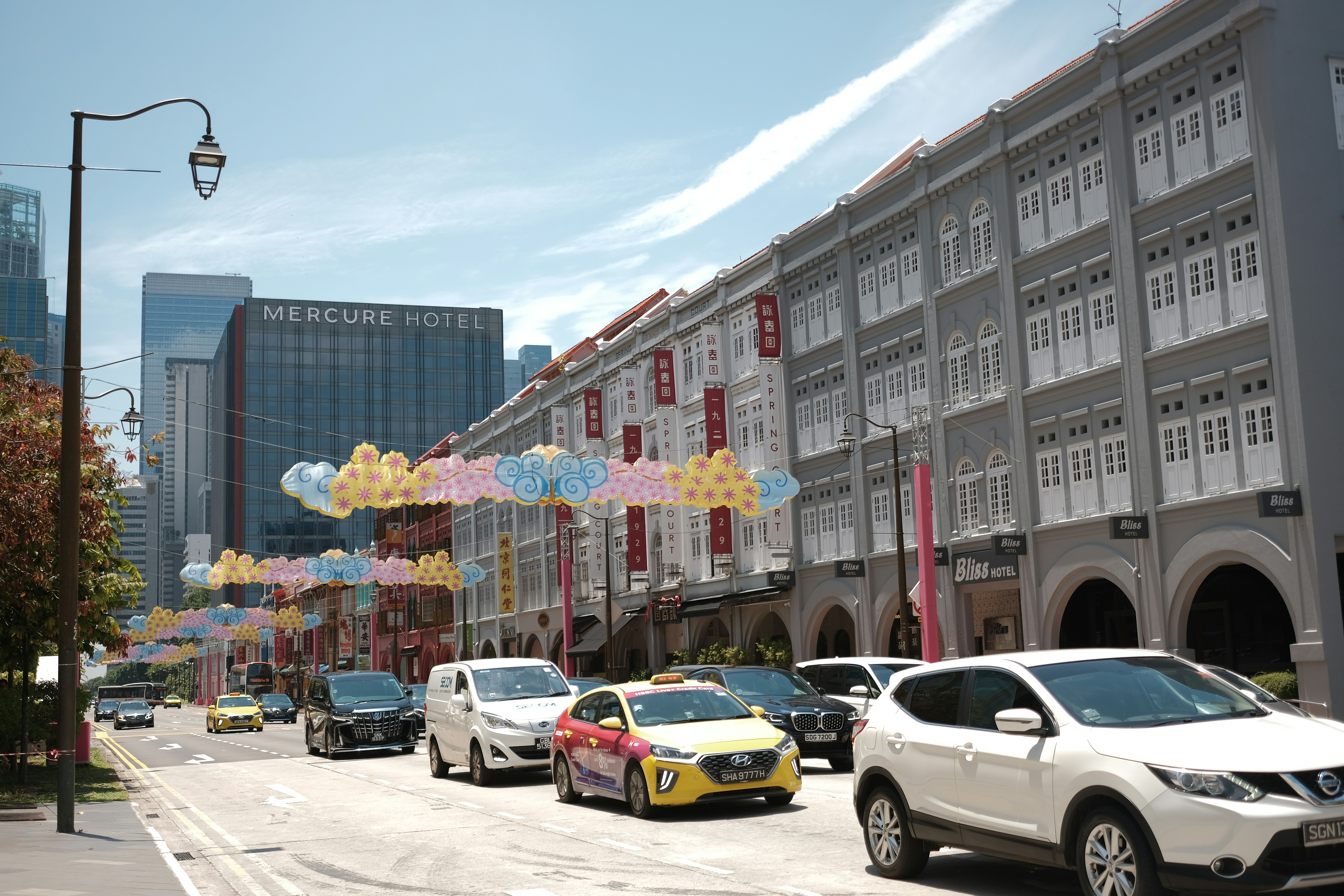 Colorful Street Scene Under a Row of Historic Arcaded Buildings