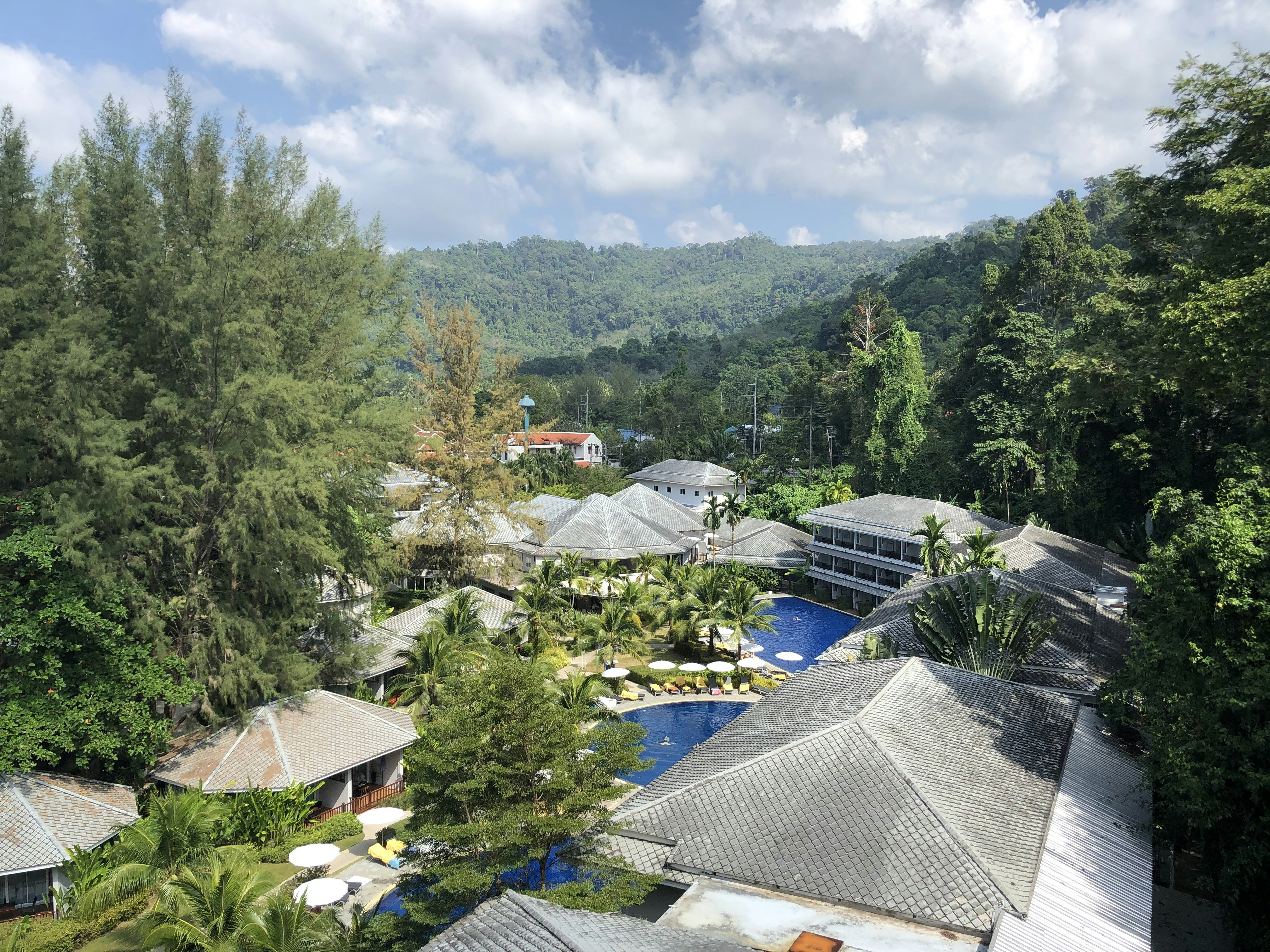 Sunlit Resort Village Circling a Velvet Pool