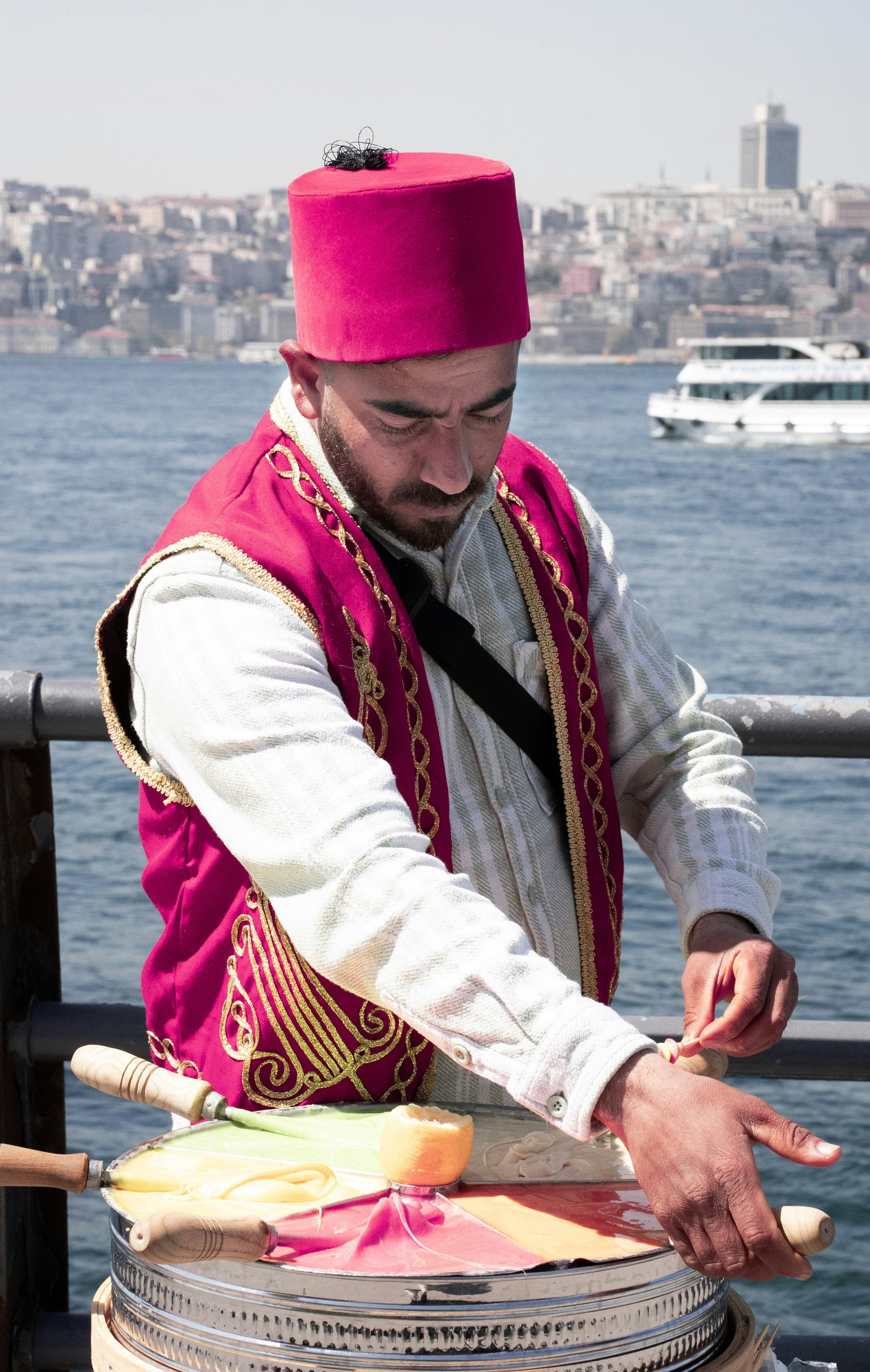 The Drummer in a Crimson Vest by the Bosphorus