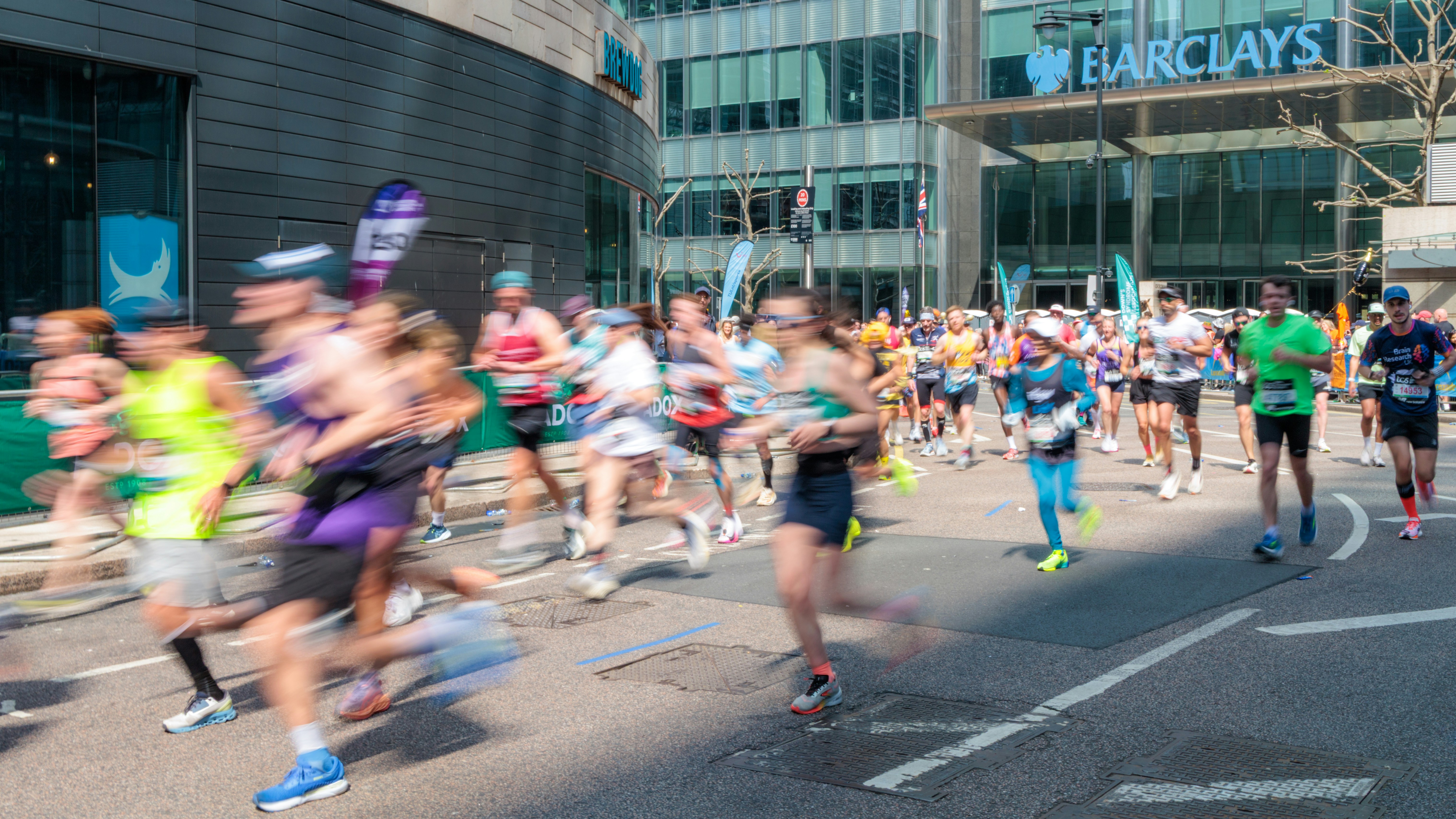 Runners participate in a marathon on a city street. photo – Free People ...