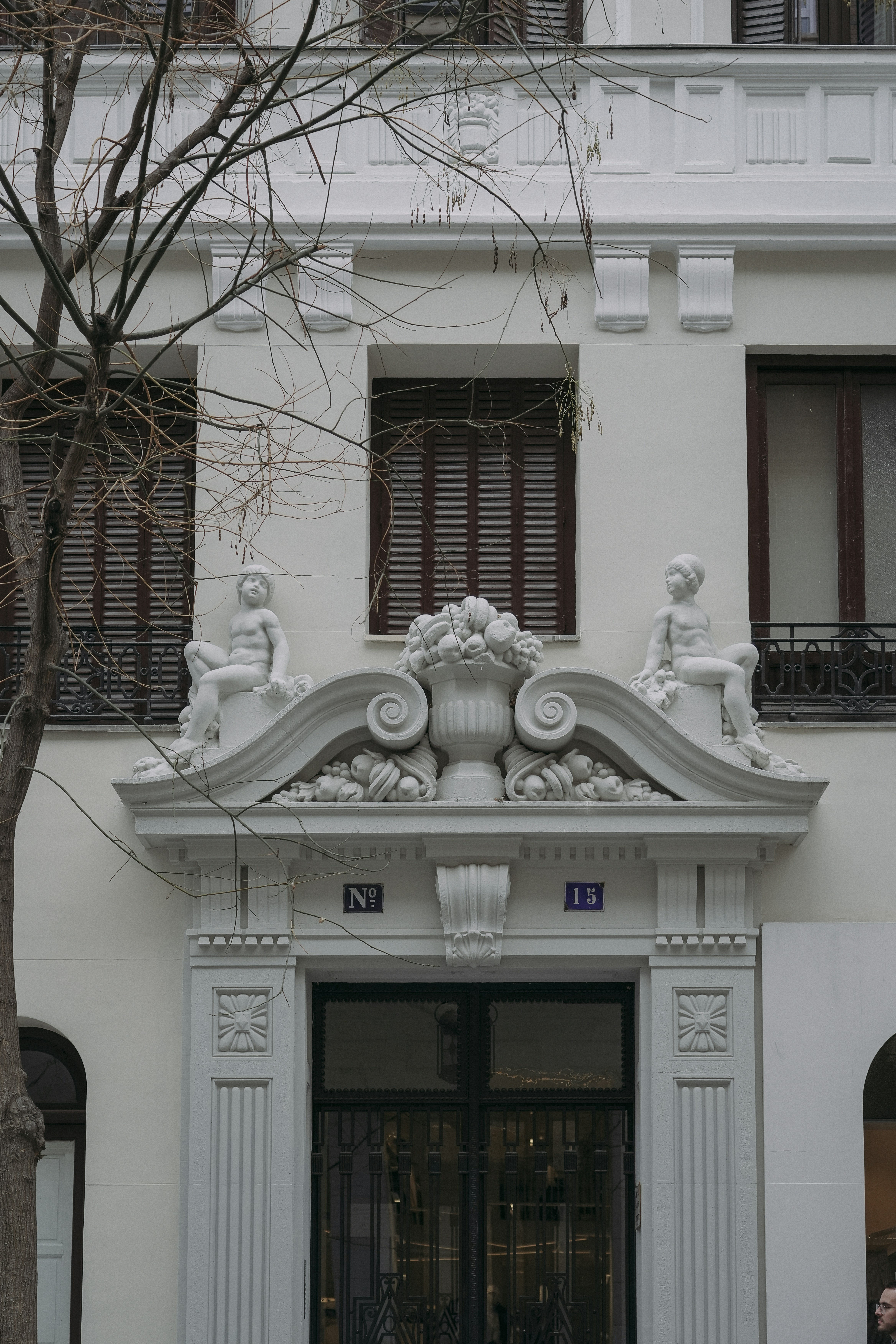 Sculpted Duo Framing a Grand Entrance with Scrollwork