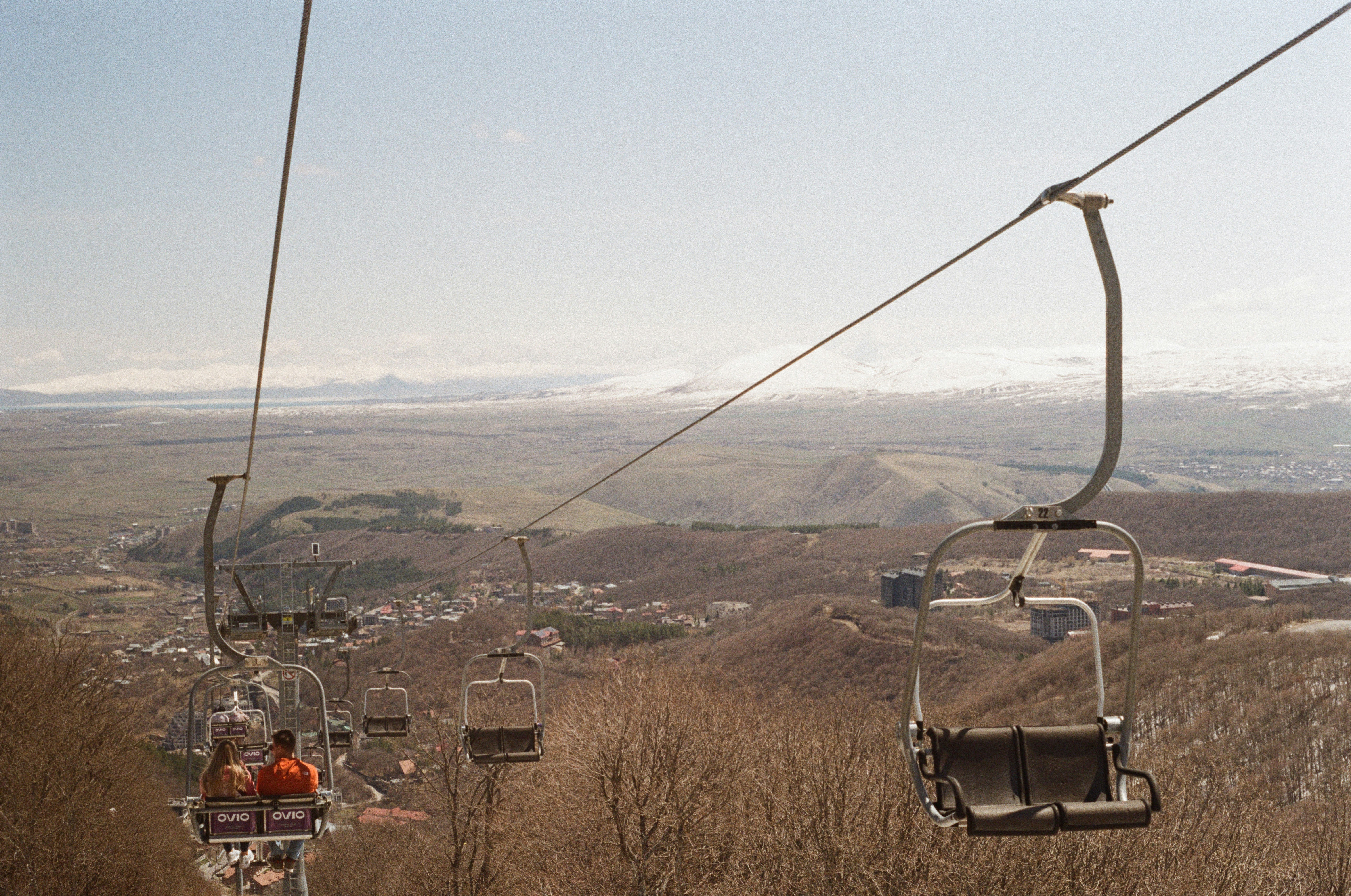 Chair lifts ascend a scenic hillside.