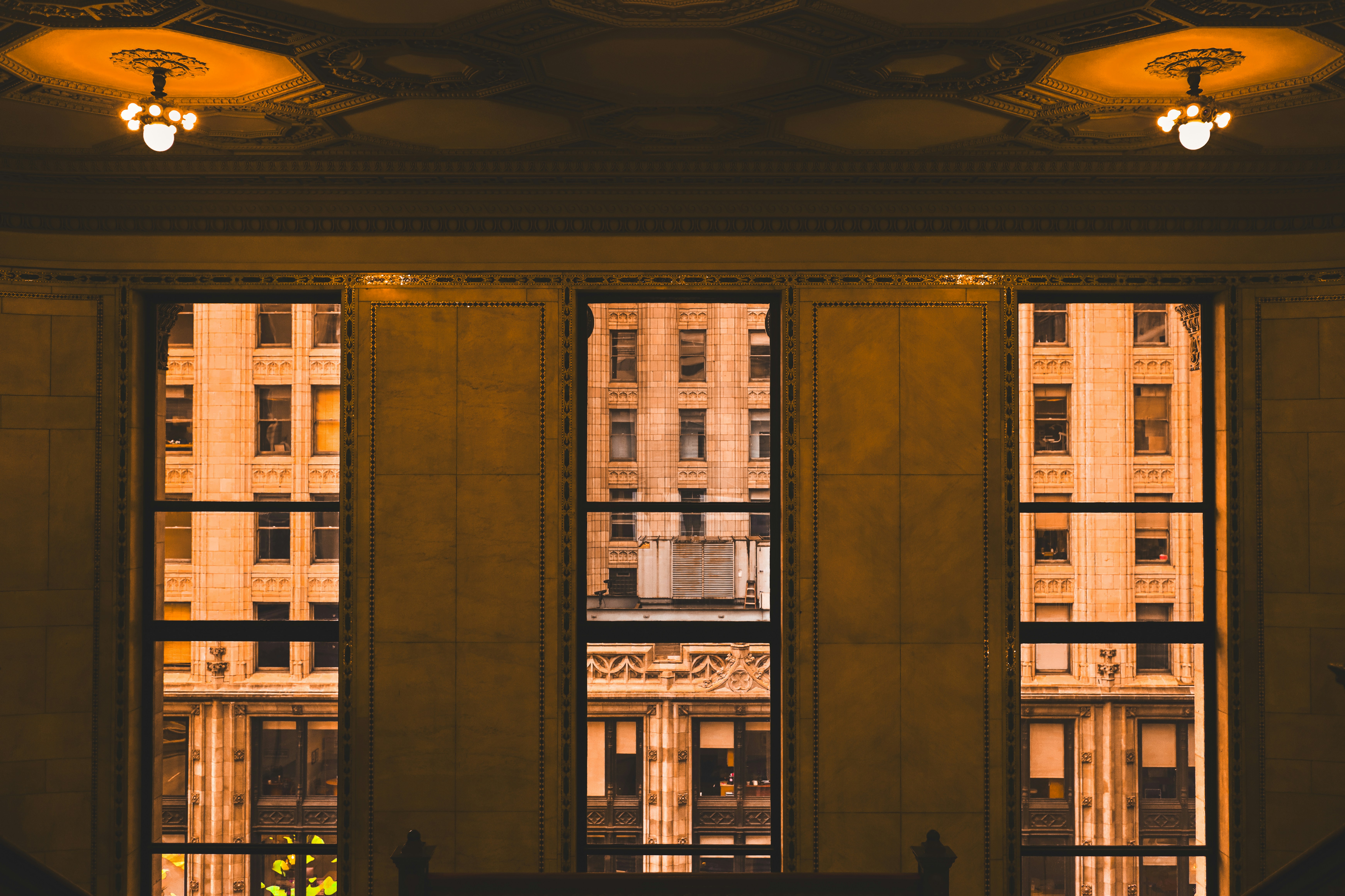 Tall windows frame buildings outside. photo – Free Golden hour Image on ...