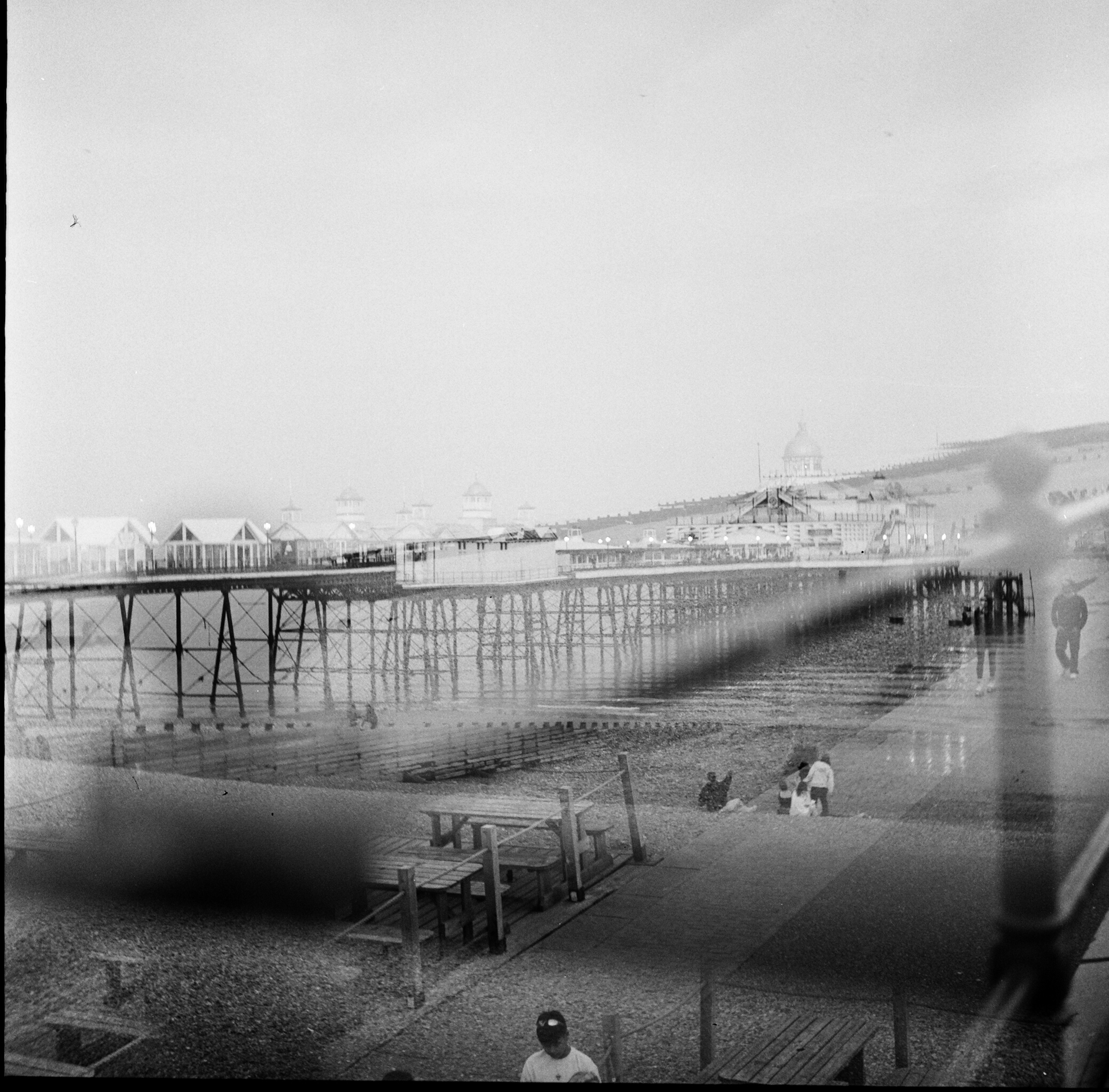 Distant Promenade: A Pier Reaches Toward the Quiet Sea
