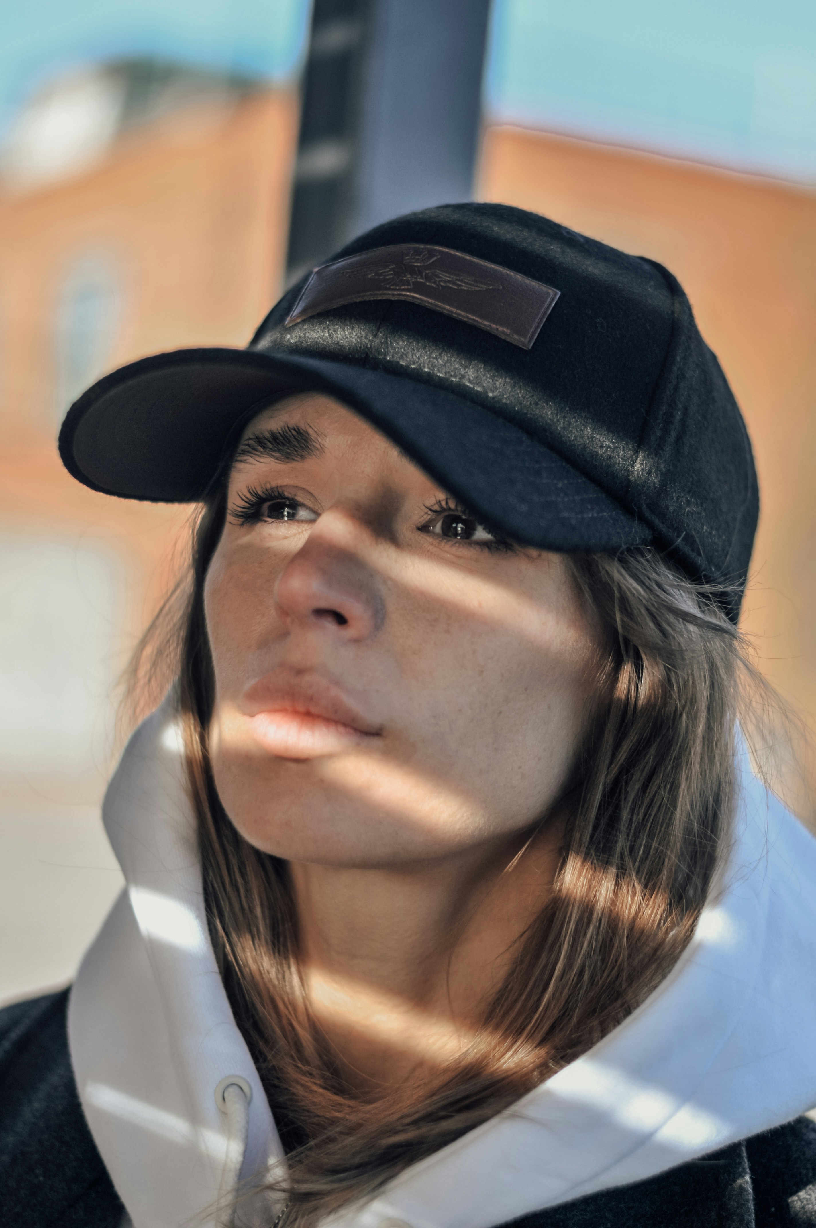 Brusnitsyn Hall walk St. Petersburg 2025 | Woman wearing a hat gazes thoughtfully.