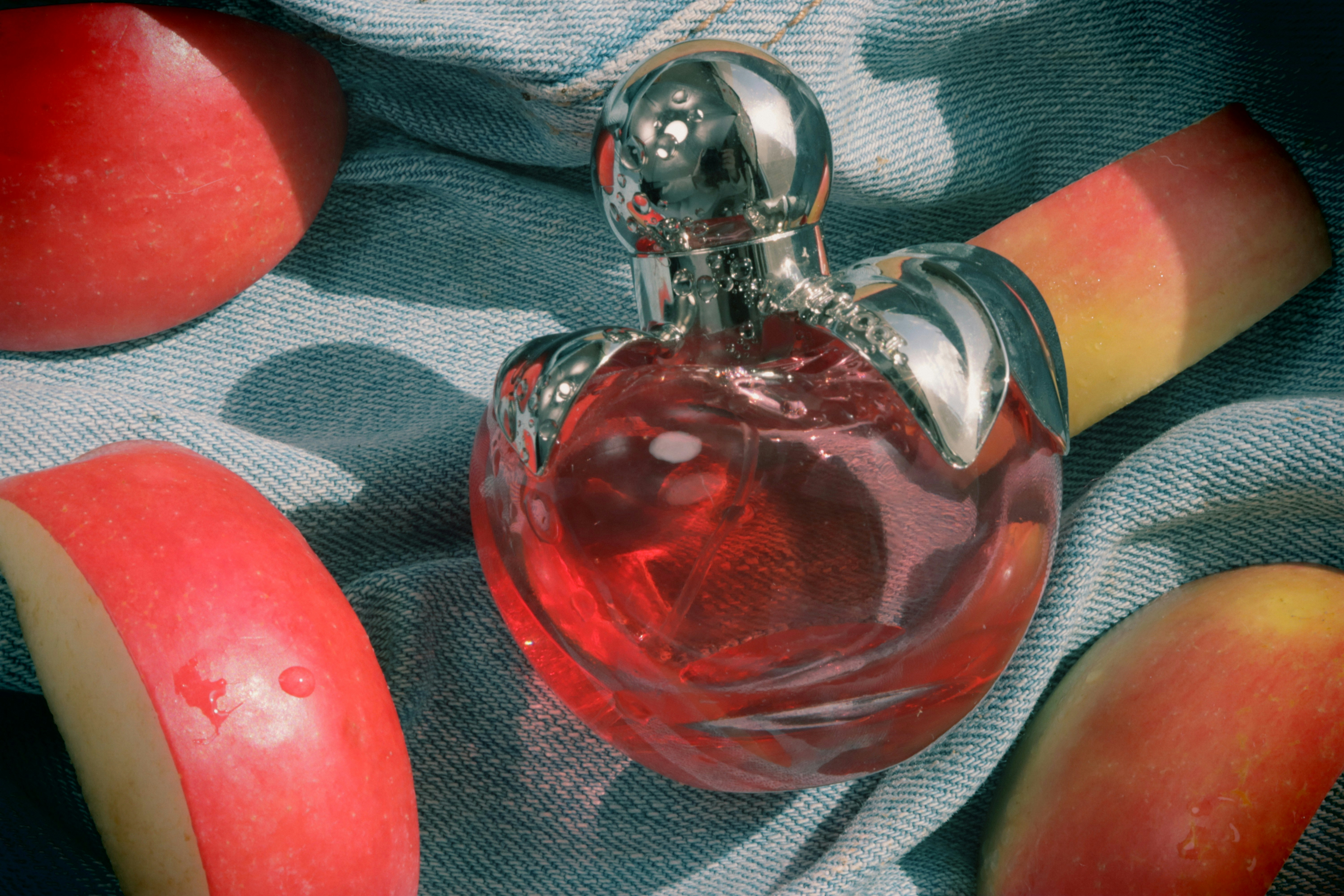 Perfume bottle shaped like a red apple.
