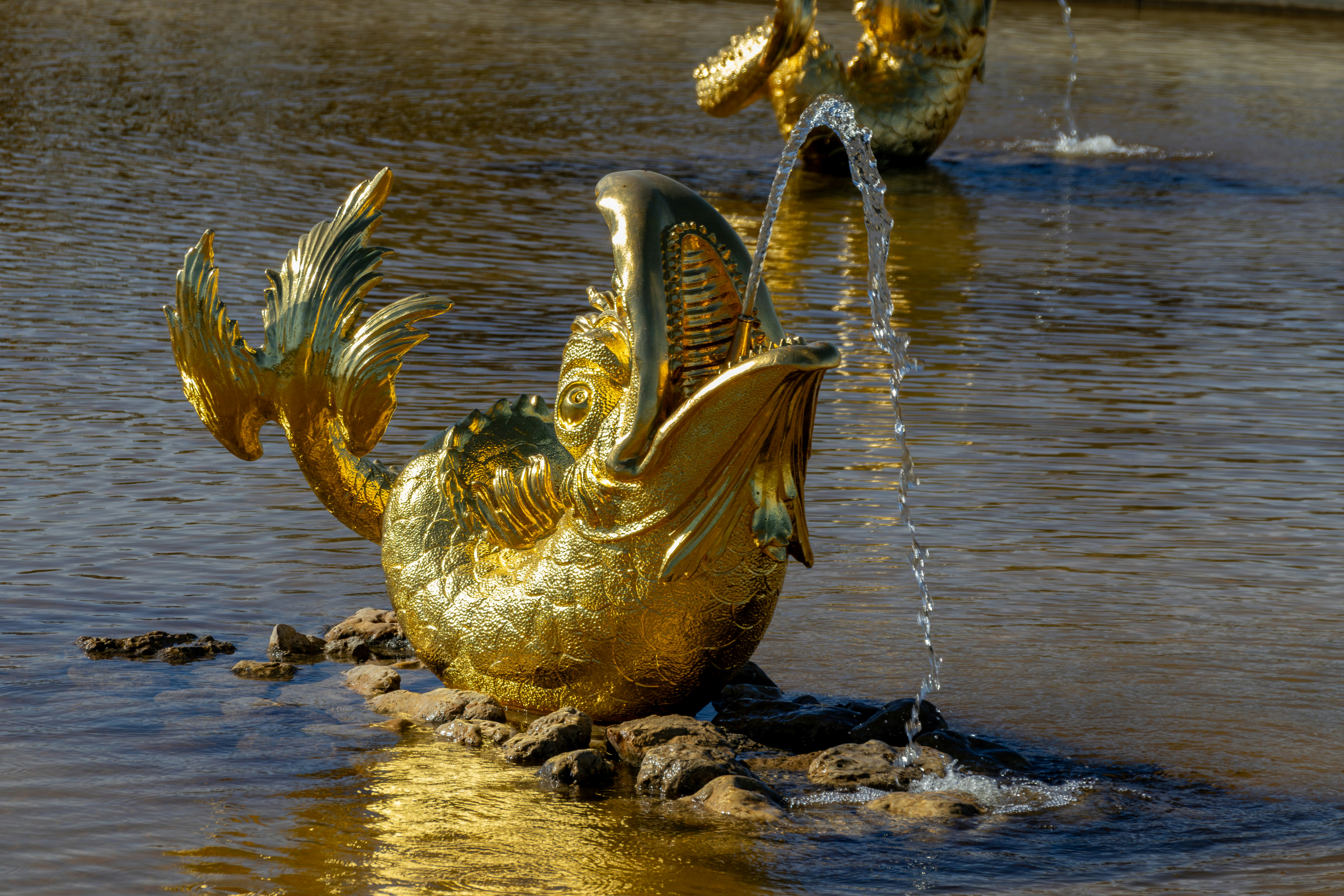 Sunlit Gilded Dragon Fountain: Liquid Gold Arcs from a Calm Pond