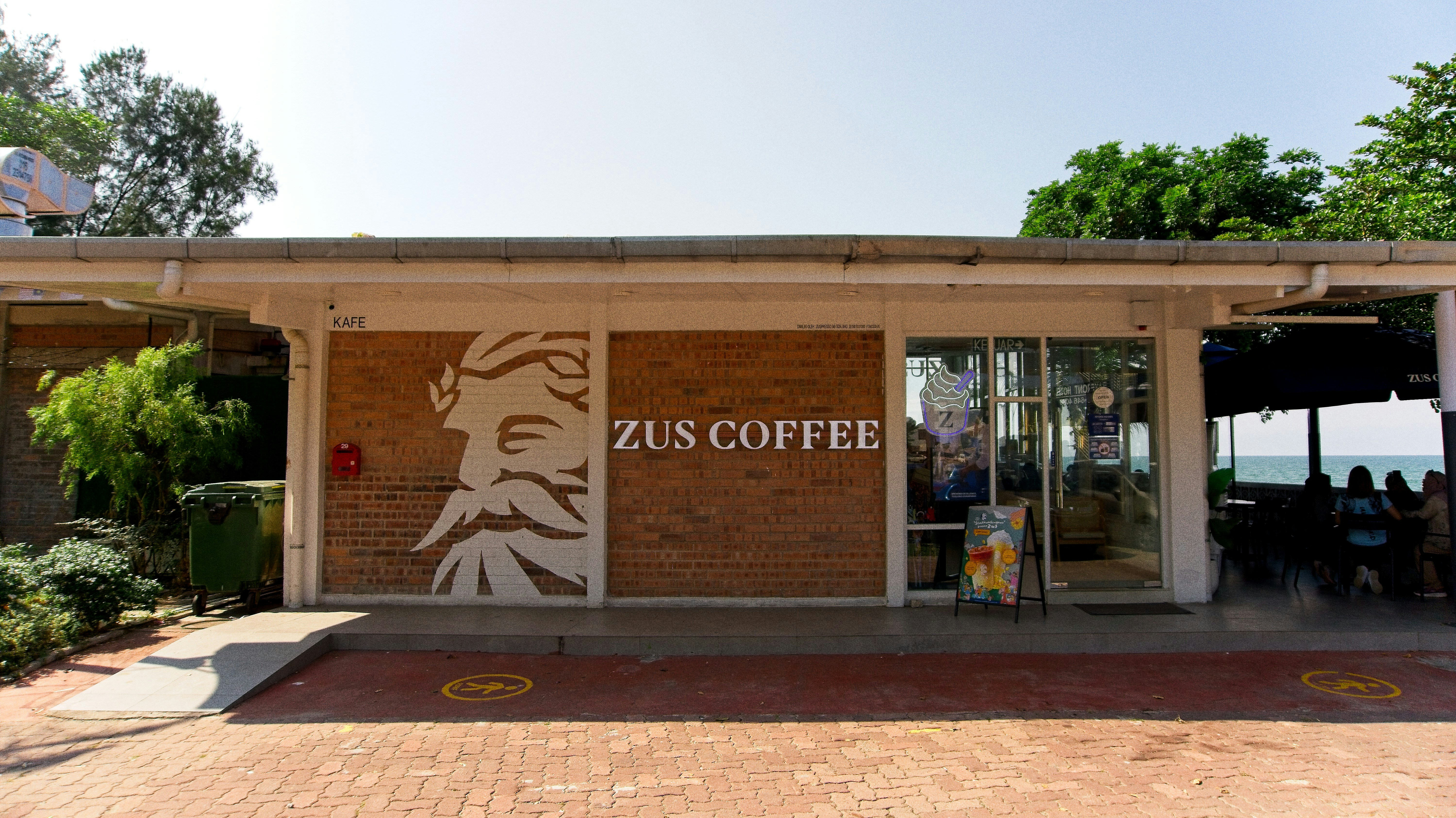 A zus coffee shop facade is displayed. photo – Free Green Image on Unsplash