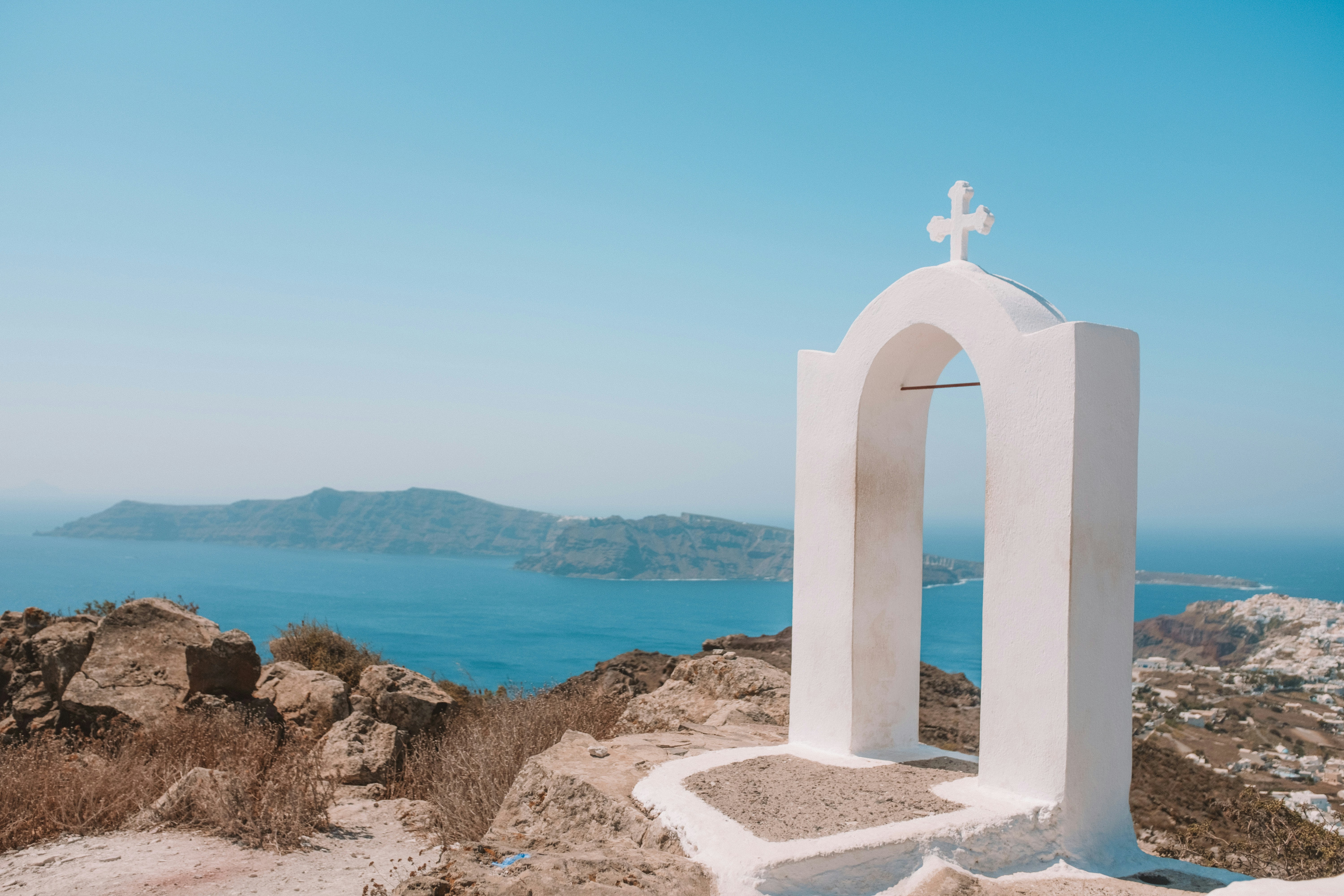 White Arch by the Aegean Cliffs, Cross Framing the Blue Horizon