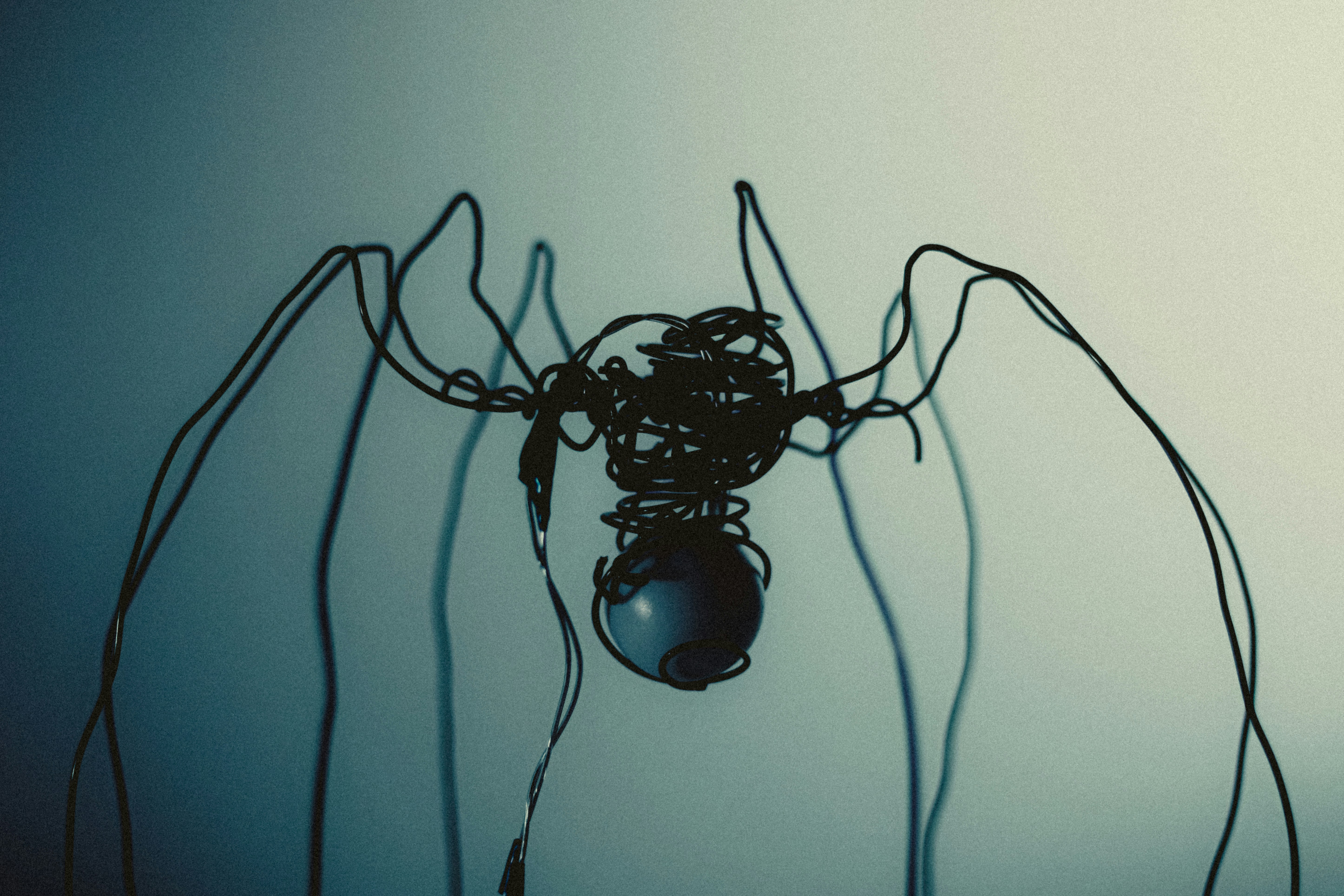 Core of the Wire: A Central Orb Enveloped by Cyan Threads
