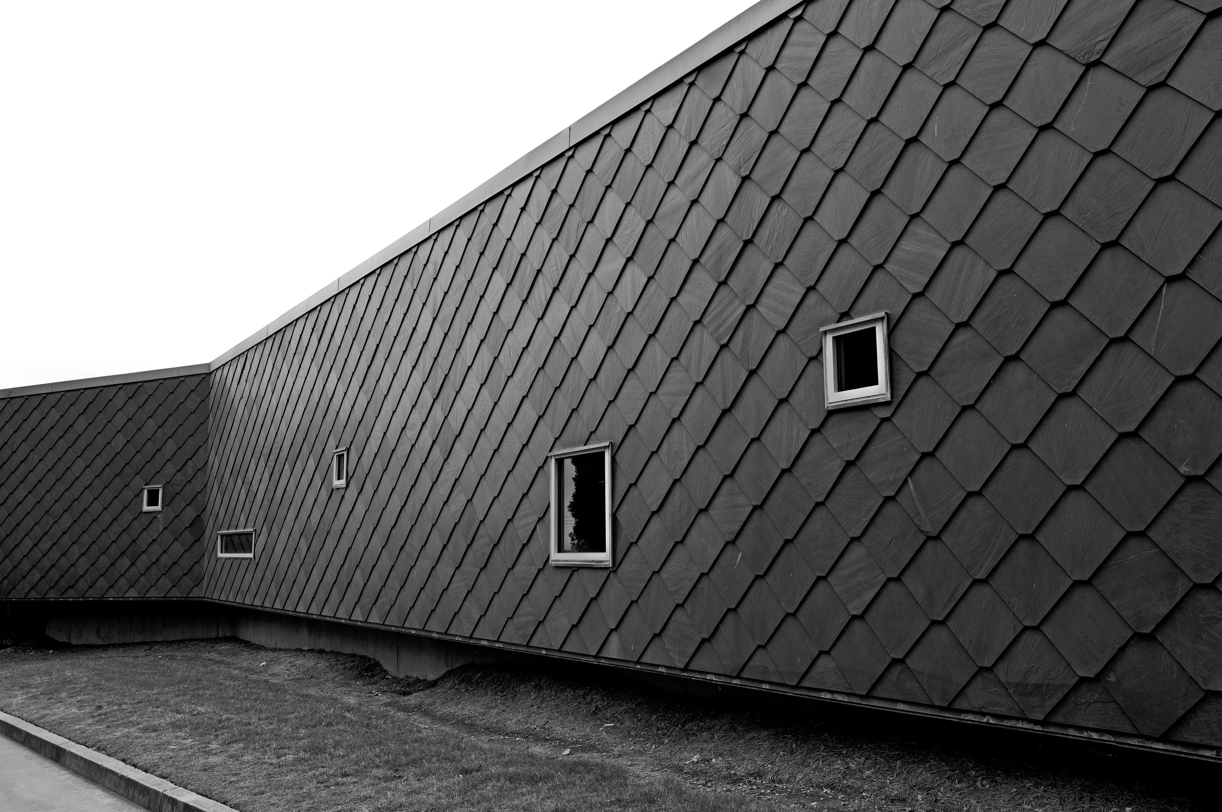 Diamond Skin, Quiet Lines: A Minimalist Wing's Diamond-Tiled Facade