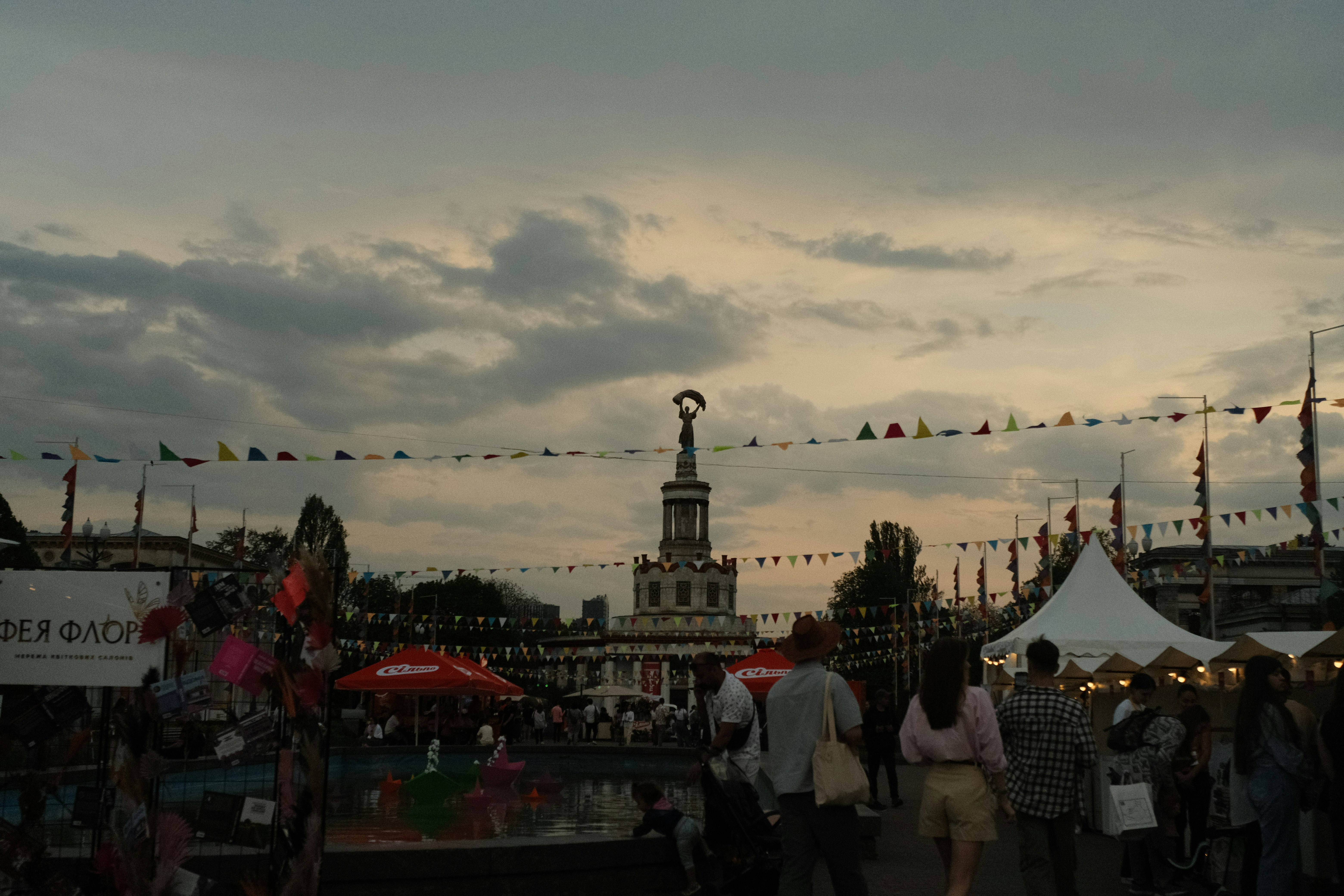 A fair or festival is happening outdoors at dusk. photo – Free ...