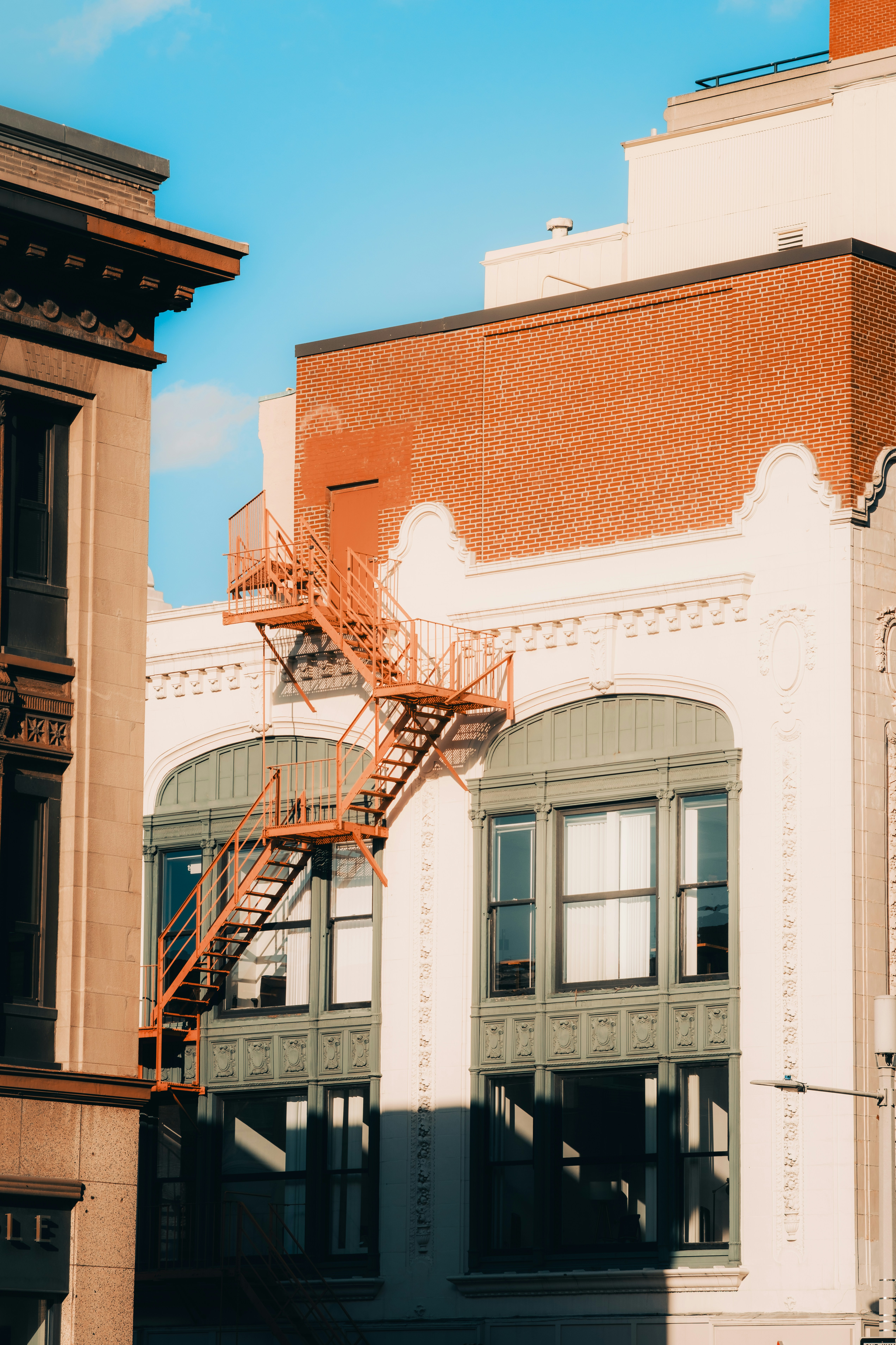 Buildings and a fire escape against a blue sky. photo – Free Street ...
