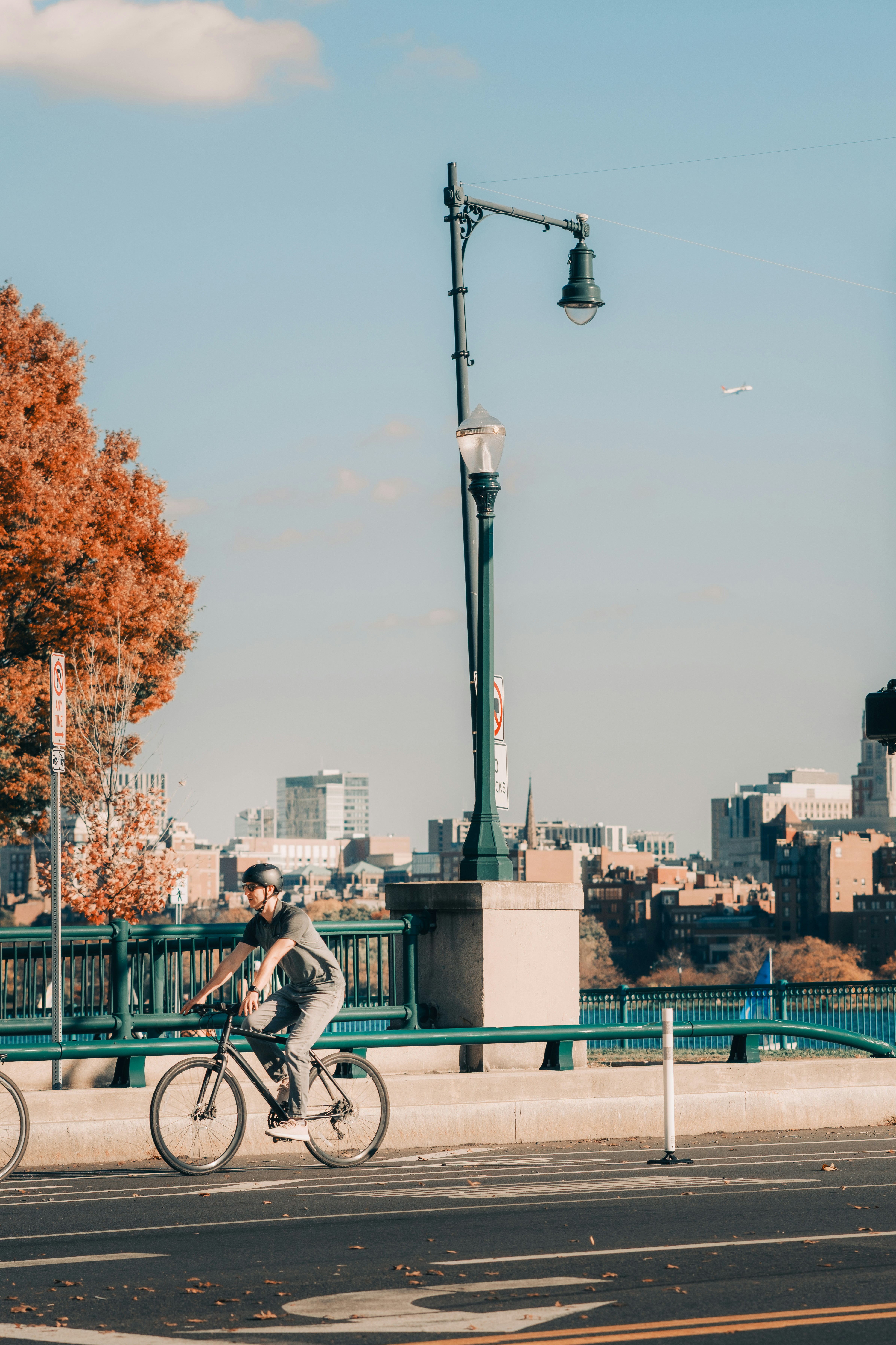 Rider on a Riverside Bridge Beneath a Clear Autumn Sky
