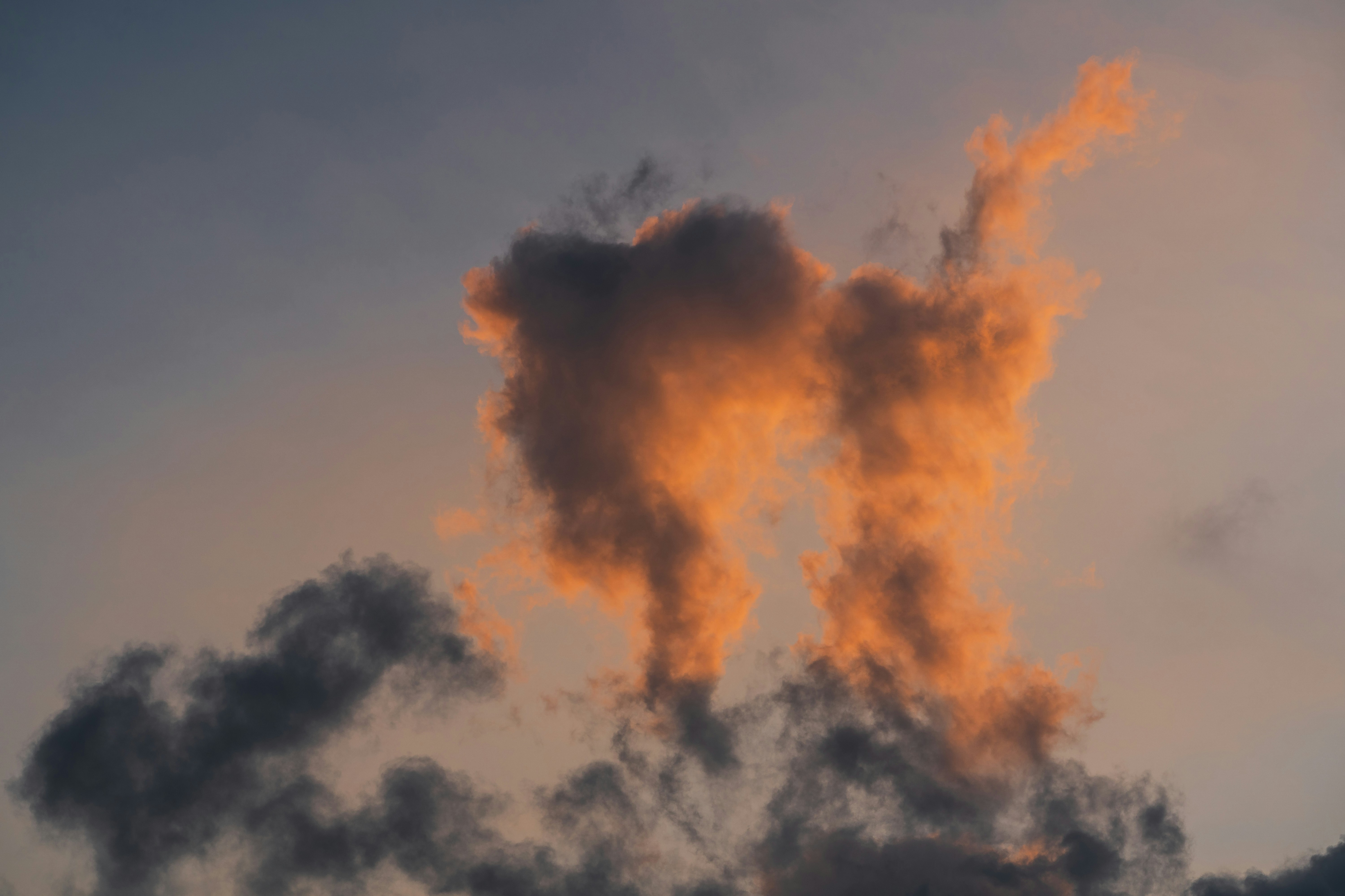 Sunlit Ember Cloud Over a Quiet Dusk Sky