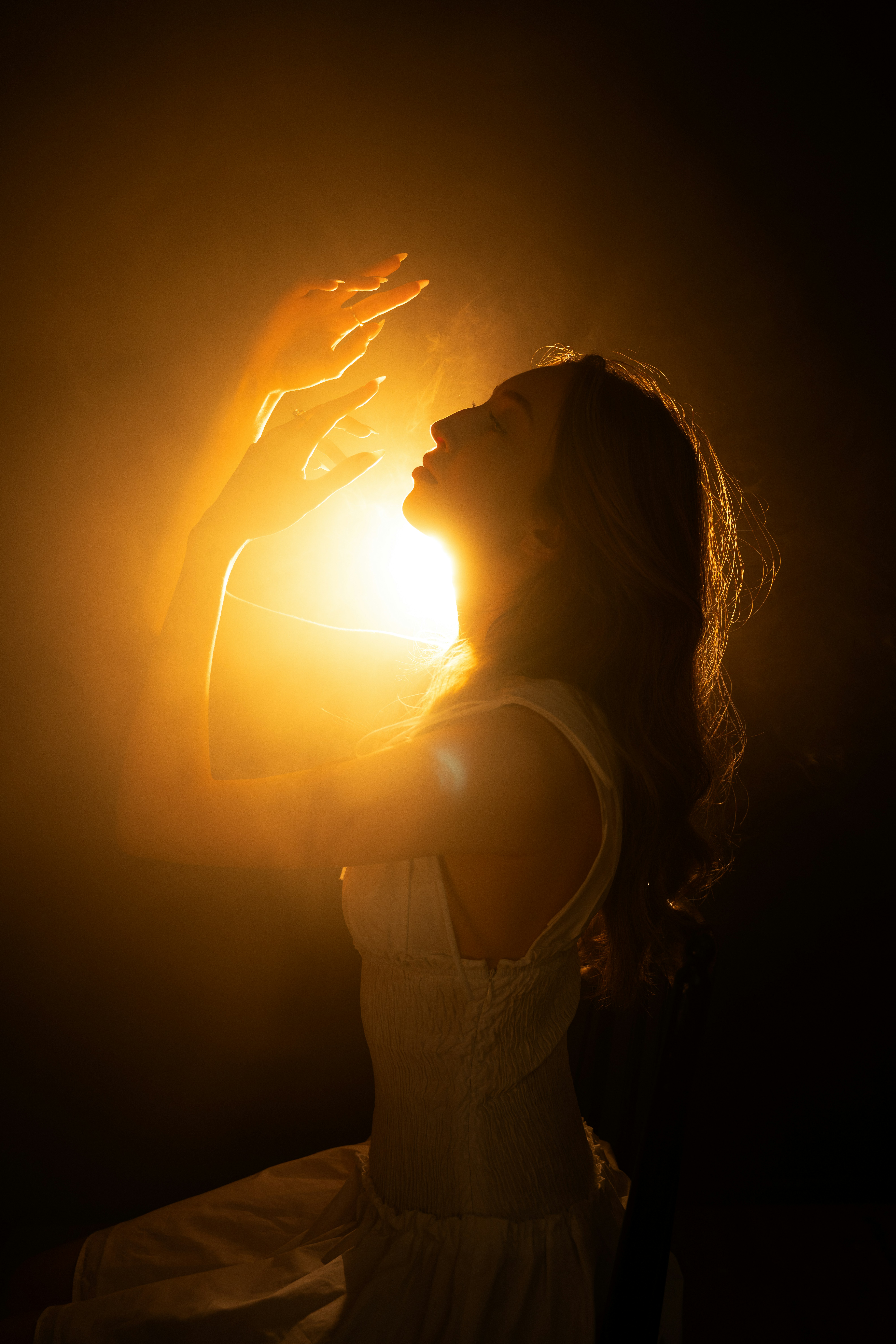 A woman reaches towards golden light. photo – Free London Image on Unsplash