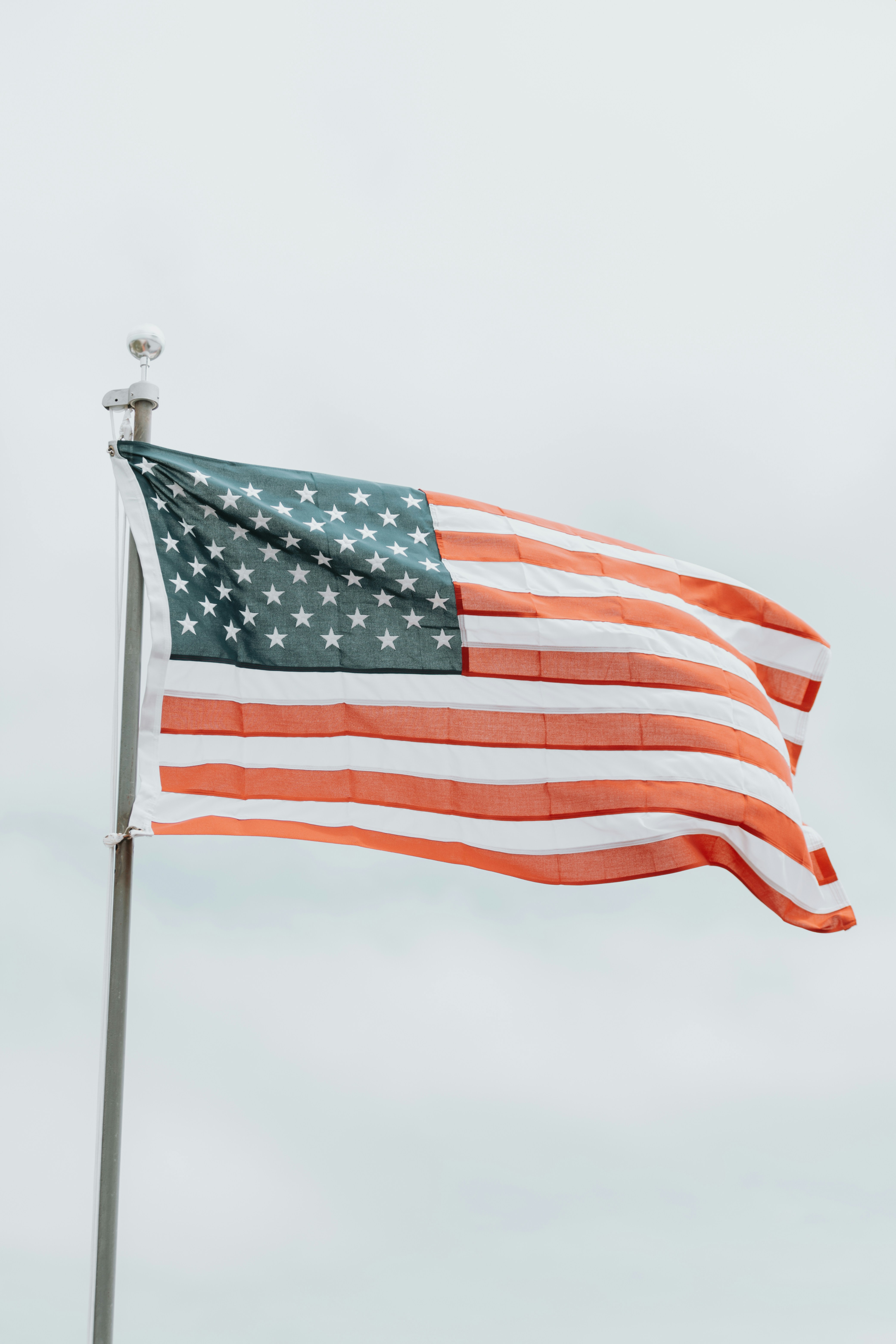 Windward Stars and Stripes: Flag Ripples Across a Pale Sky