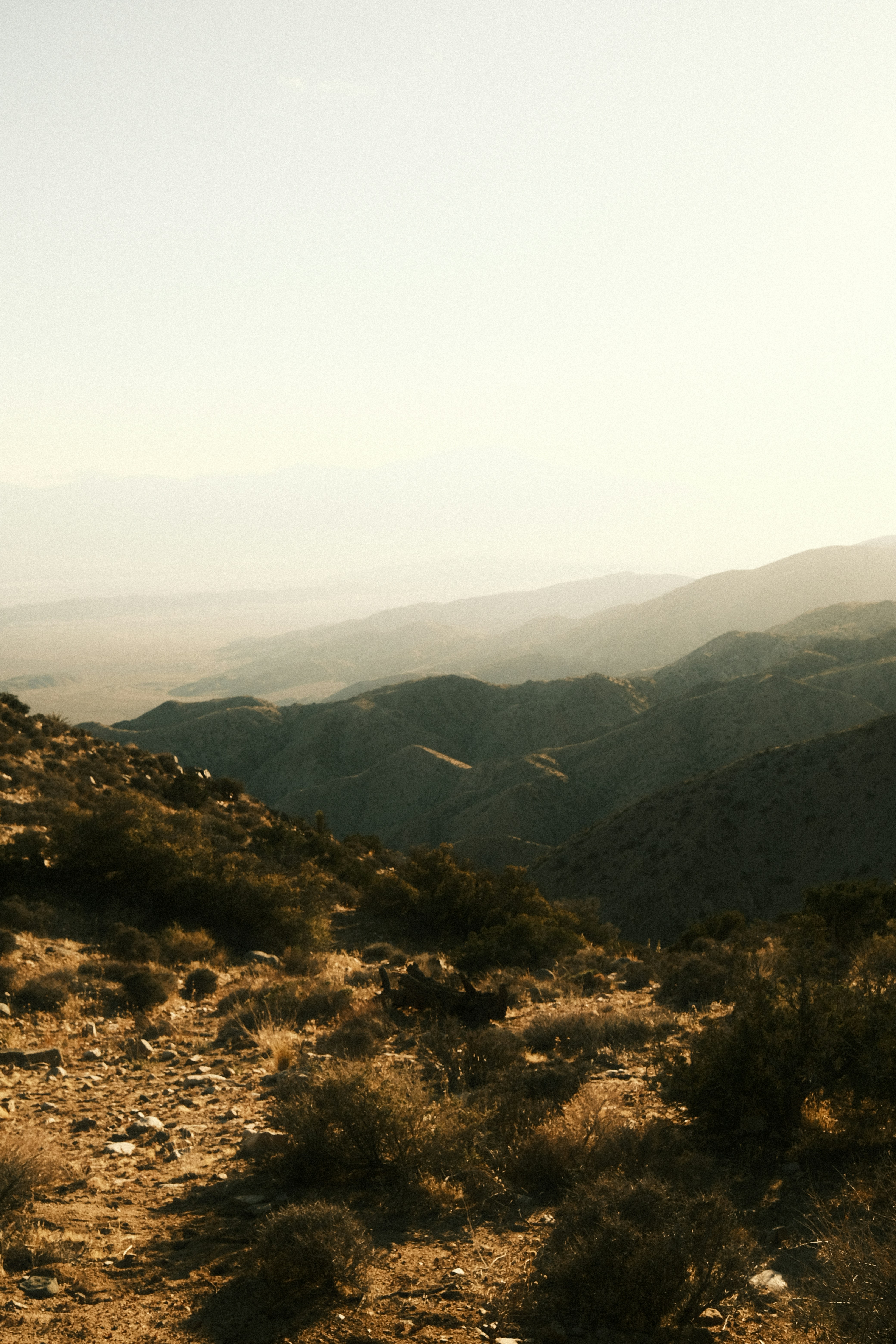 Mountains fade into a hazy, golden distance. photo – Free Image on Unsplash