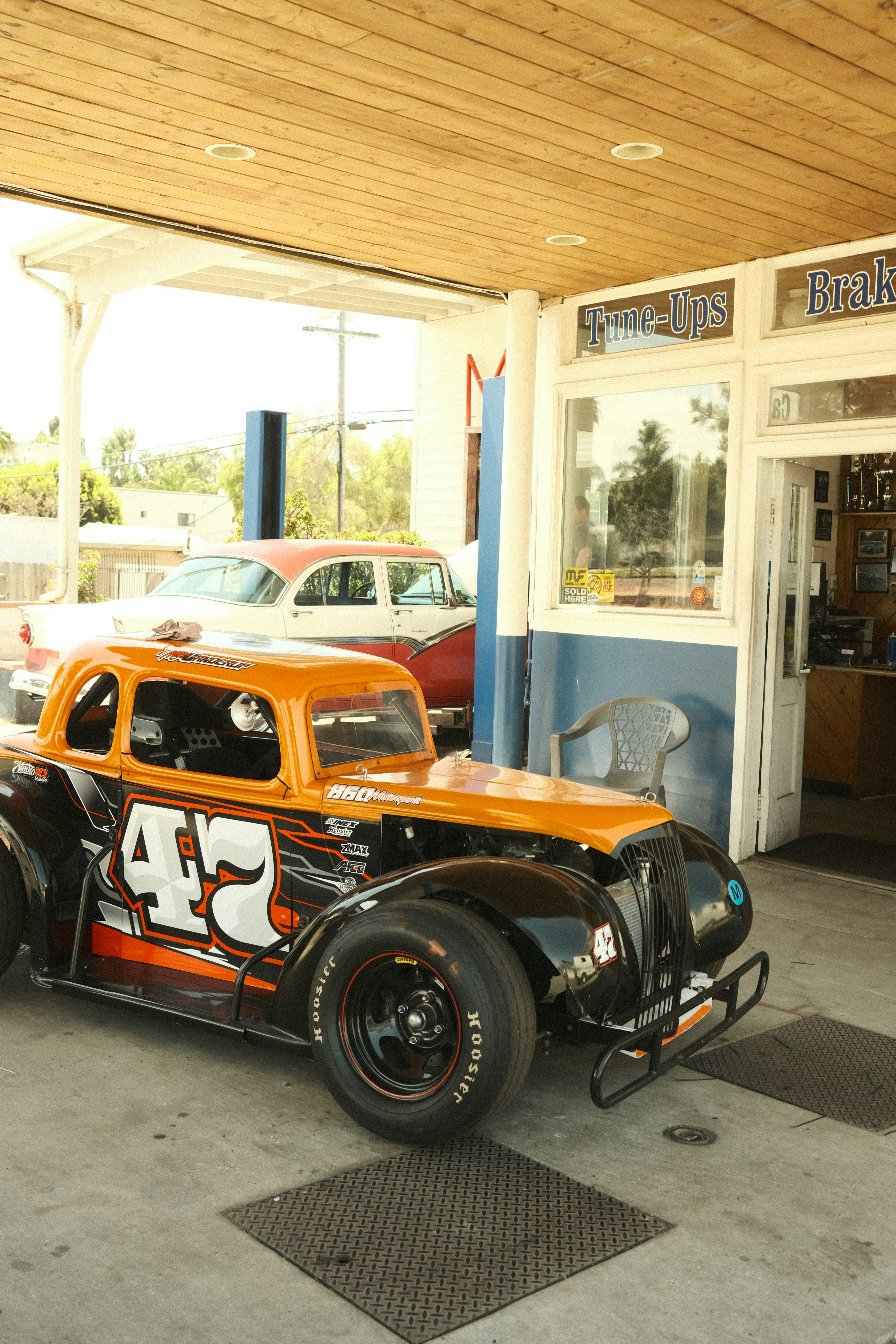 Orange race car at a retro service station