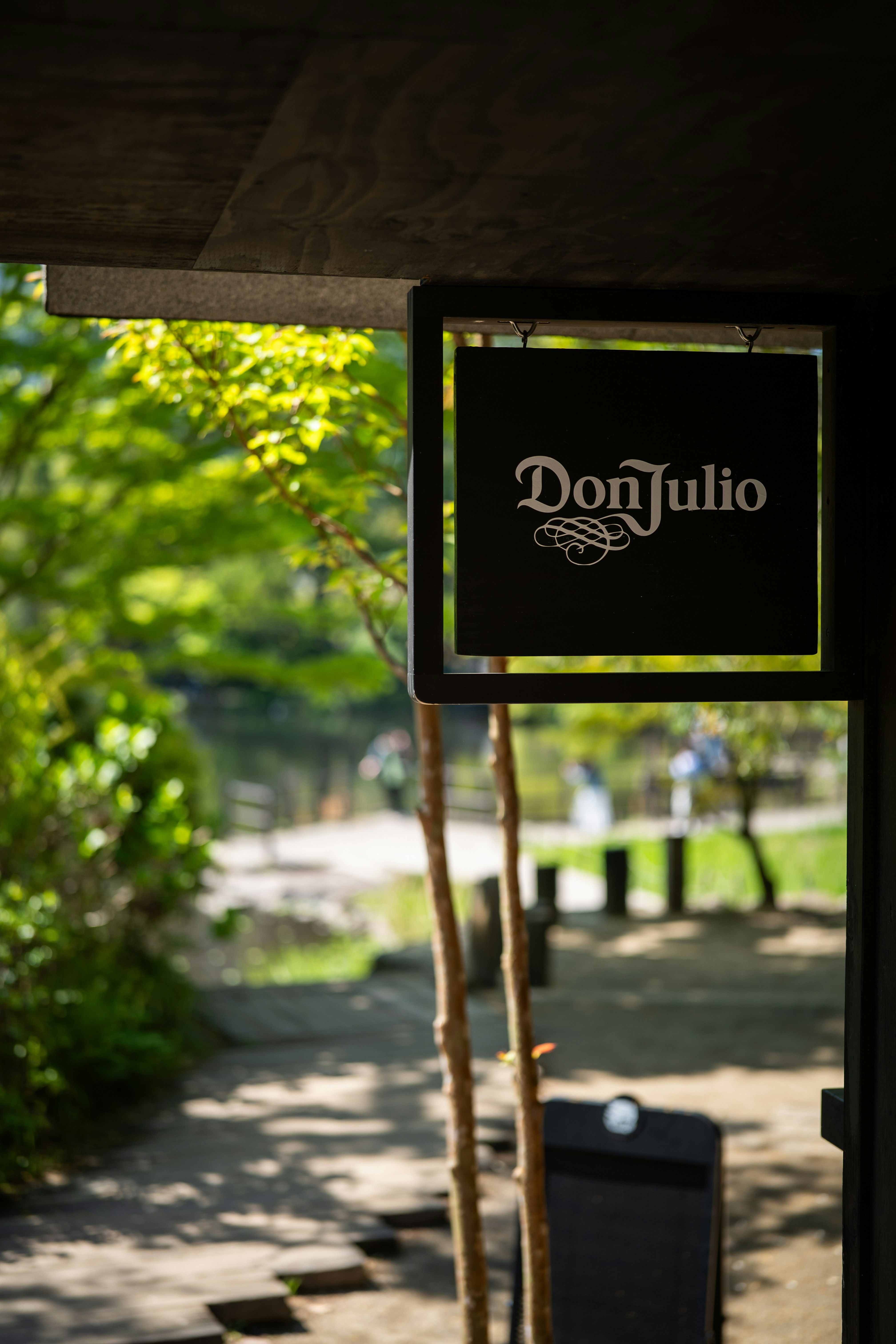 DonJulio Sign Framed by Light in a Quiet Courtyard