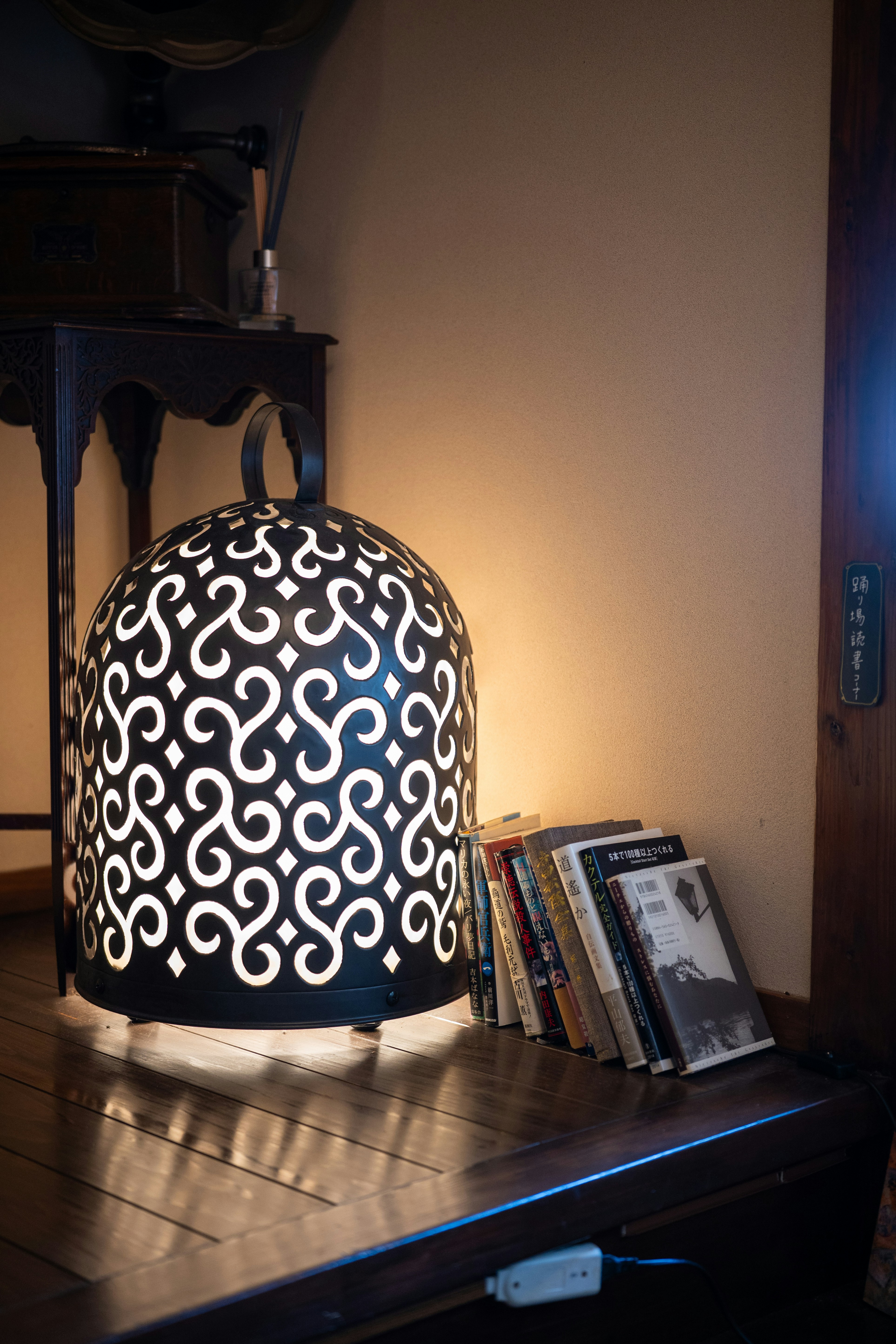 Loom of Light: A Patterned Lamp Anchors a Quiet Bookshelf Corner