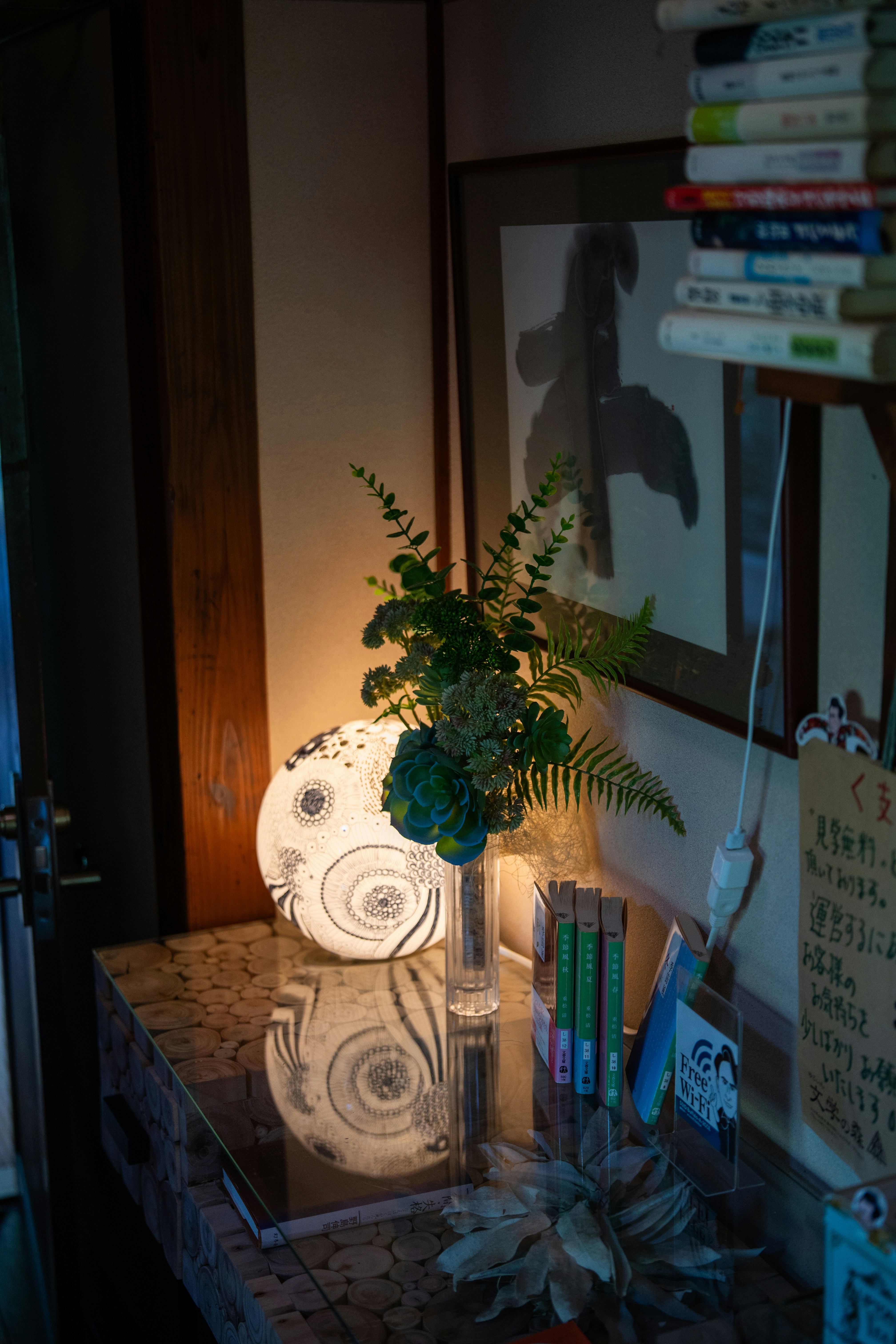 Soft Glow and Greenery on a Dimly Lit Console