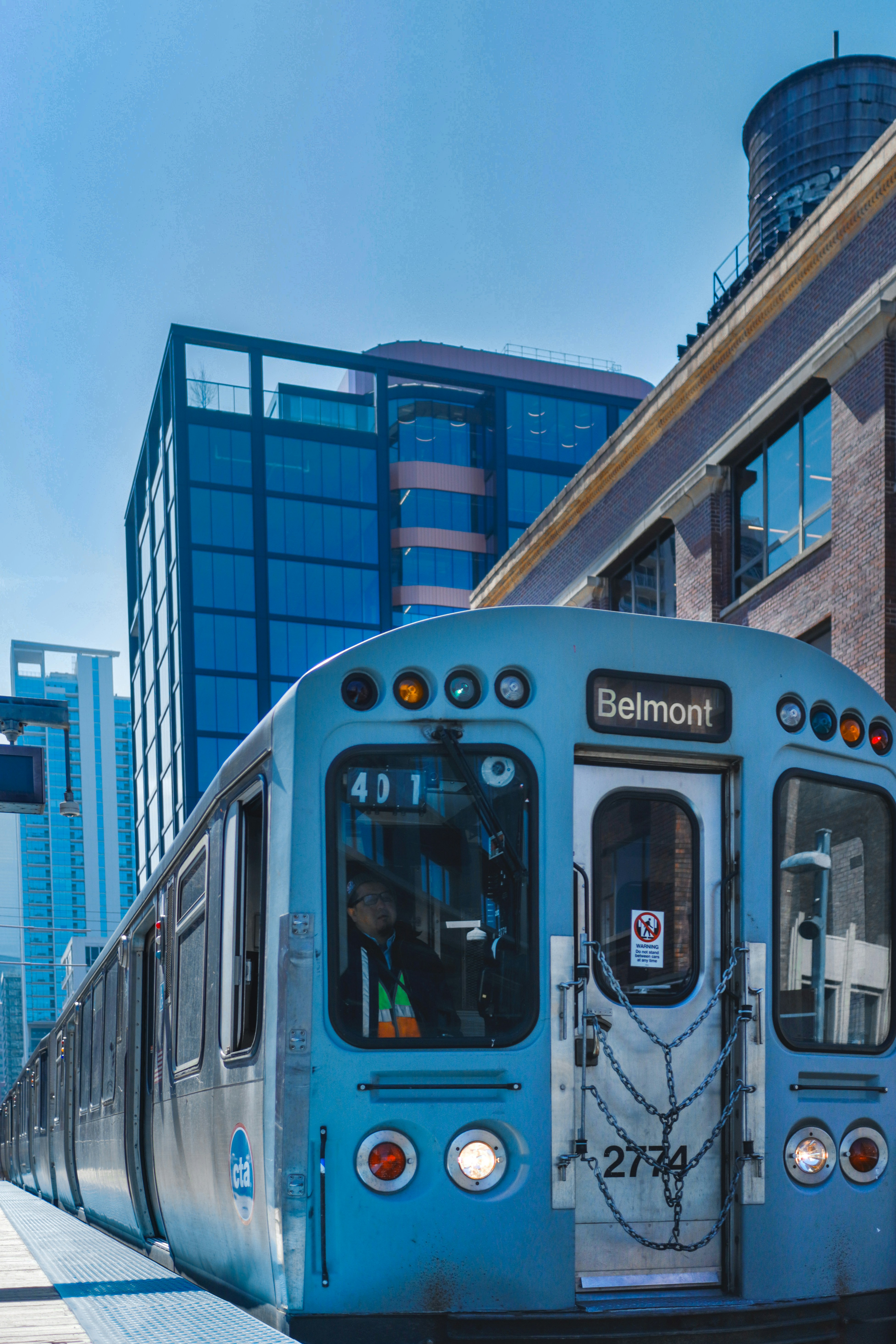 Belmont on Rails: A Blue Metro Framed by Glass Skyscrapers