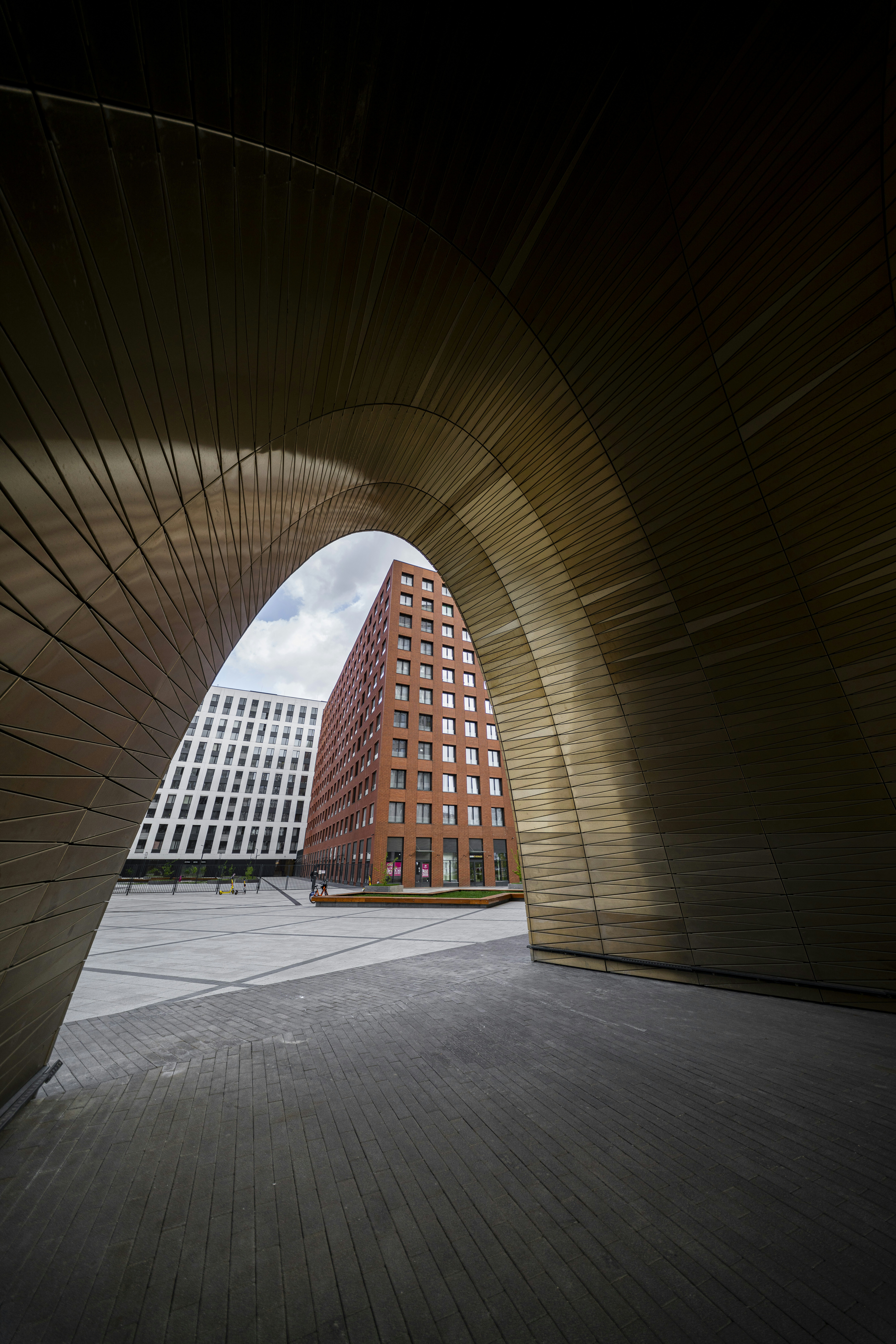 Under the Golden Arch: City Lines Framed by Steel and Brick