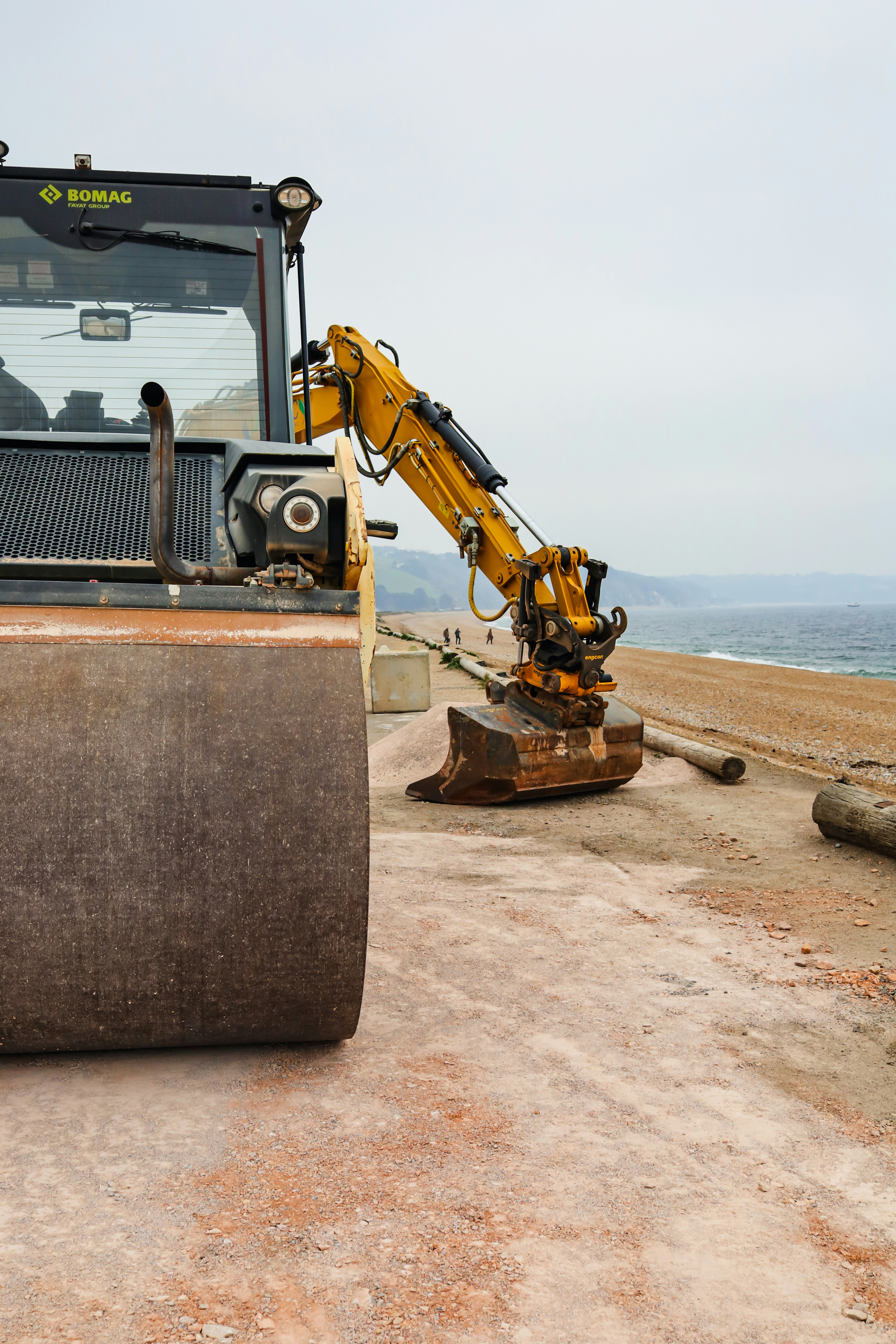 Construction vehicles work by the ocean. photo – Free Image on Unsplash