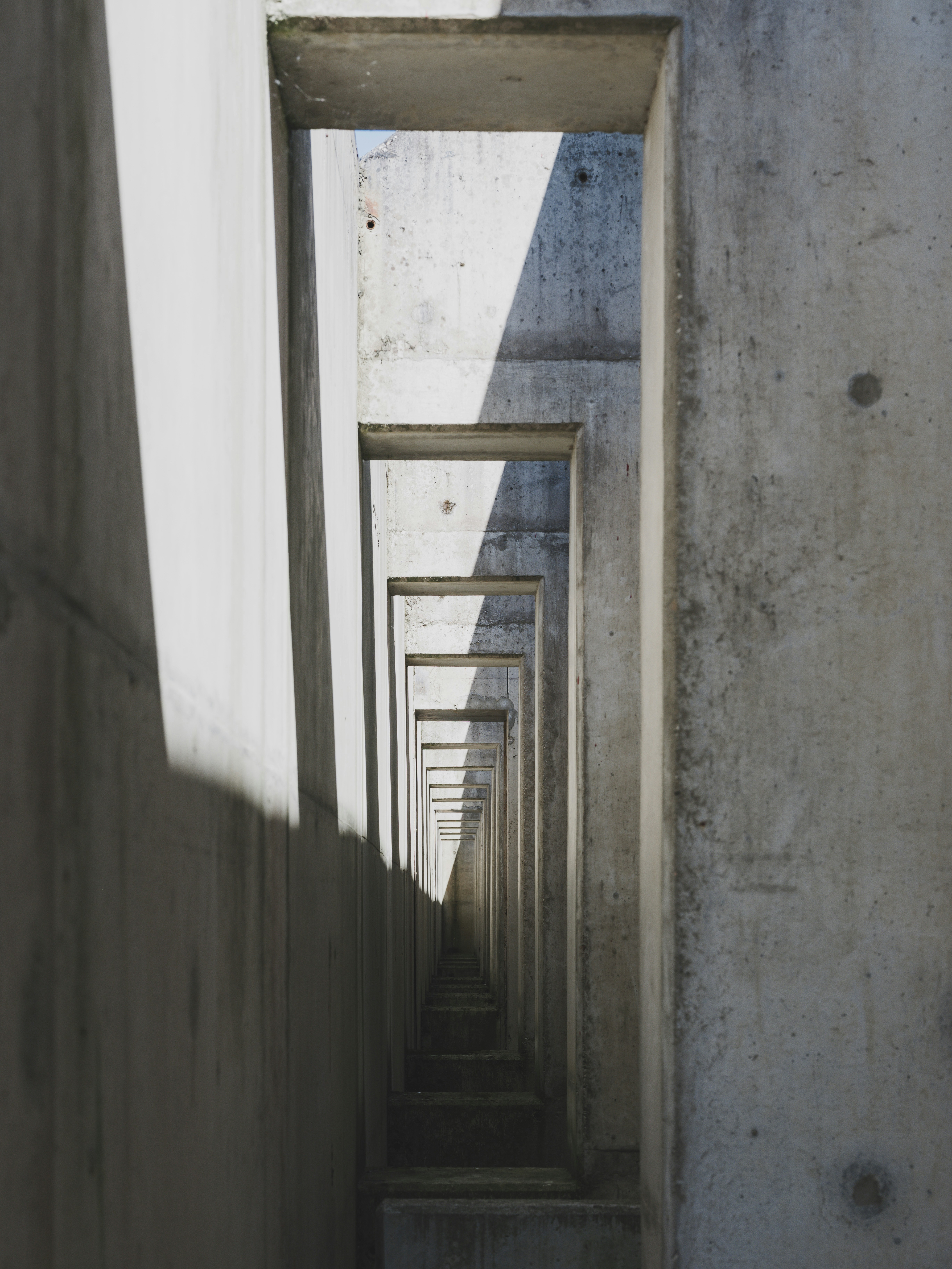 Concrete doorways lead into a receding corridor. photo – Free Abstract ...