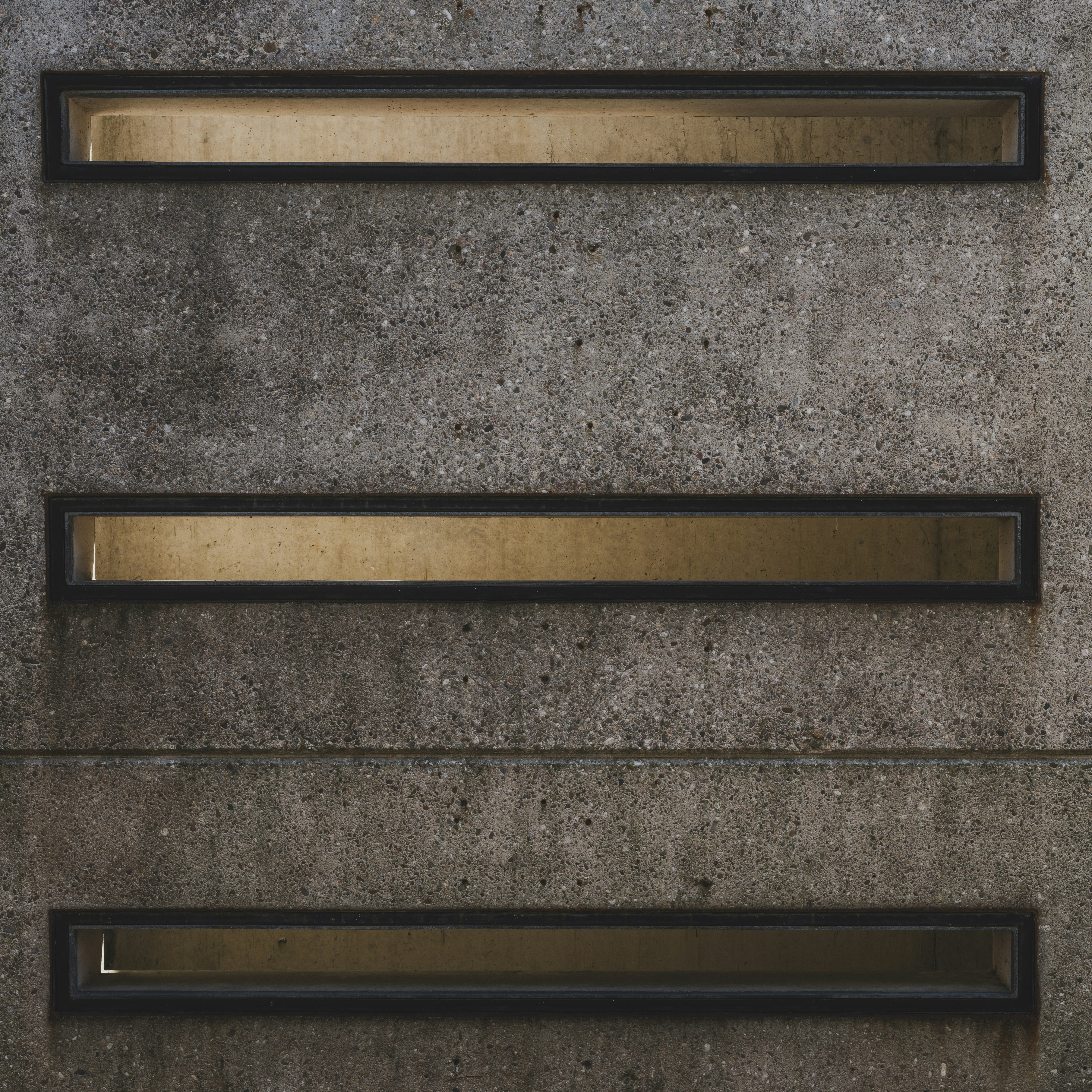 Horizontal Echoes: Three Recessed Windows in Textured Concrete