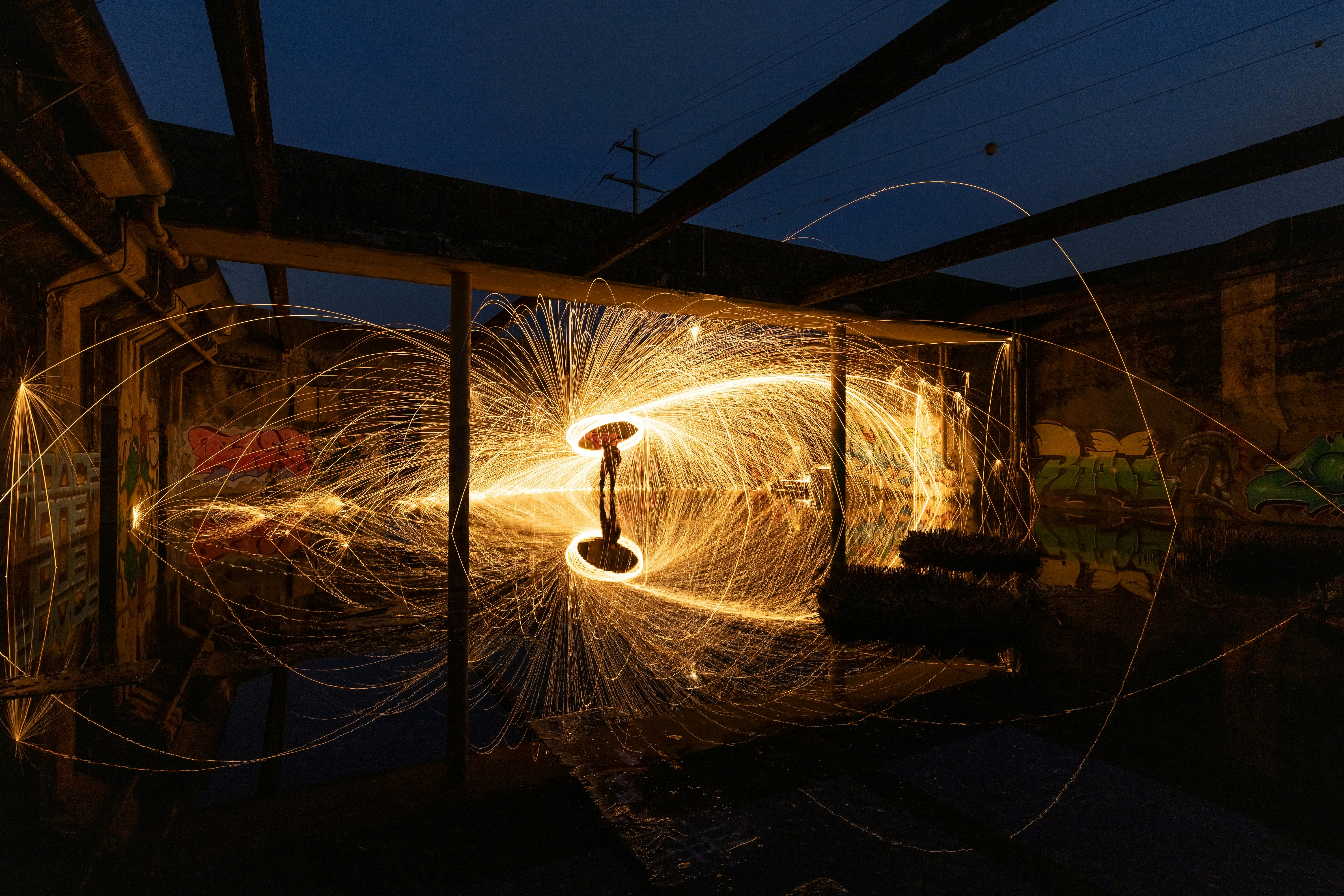 Spinning Sparks: a steel-wool performance in a shadowed loft