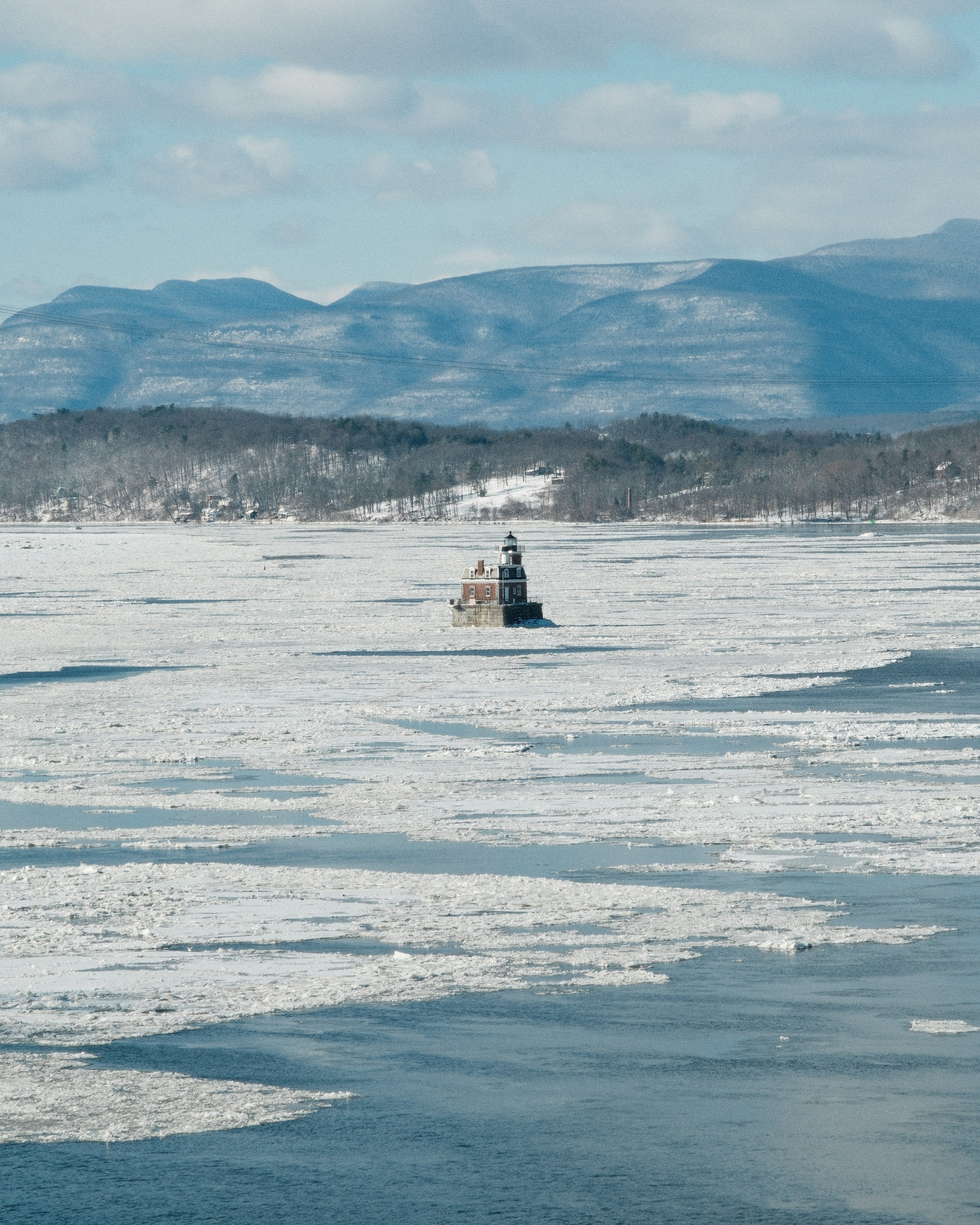 A lighthouse sits amid ice floes and mountains. photo – Free Winter ...