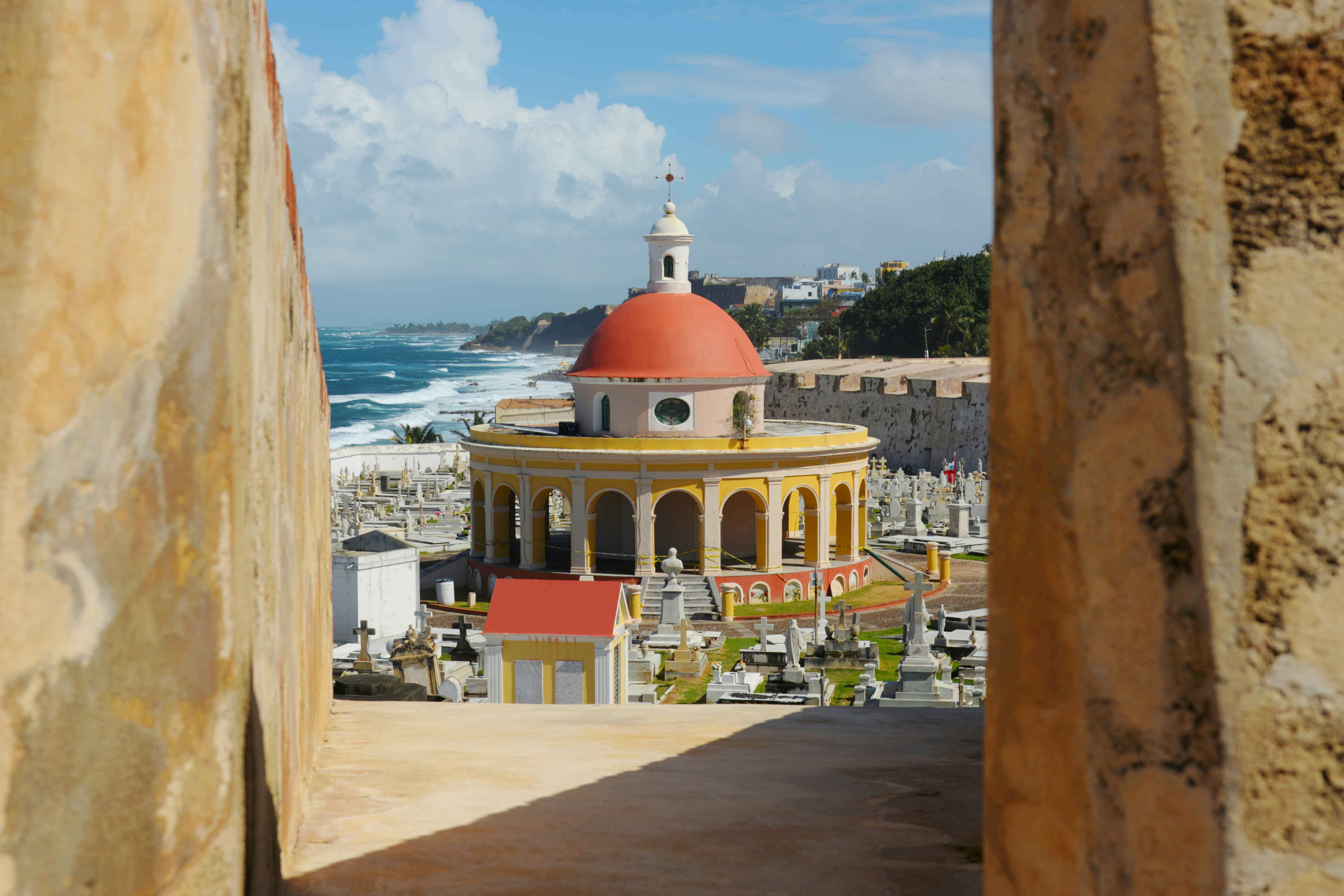 Dome Over the Sea: Sunlit Pavilion Framed by Stone Fortresses