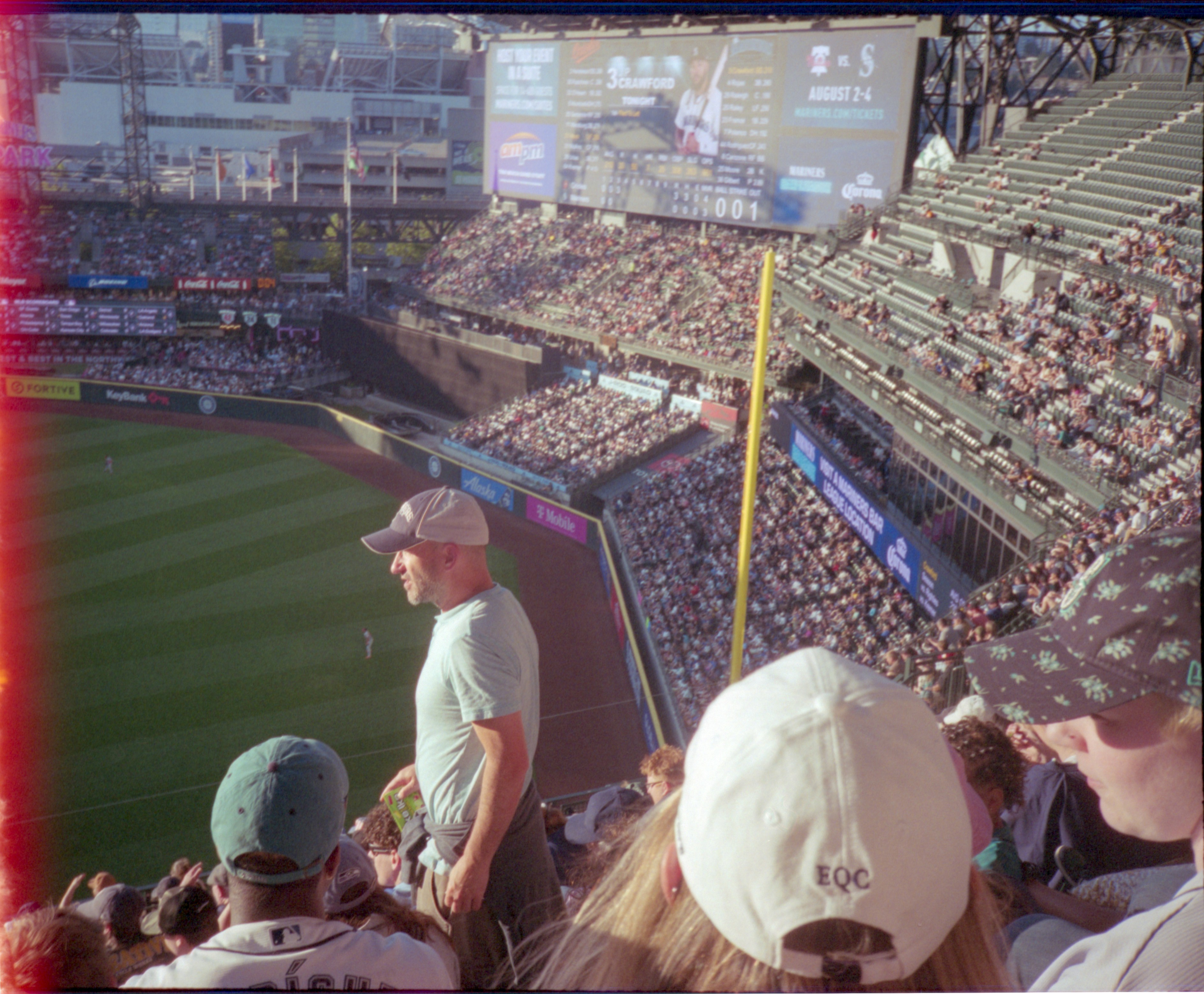 Fans watch a baseball game from the stands.