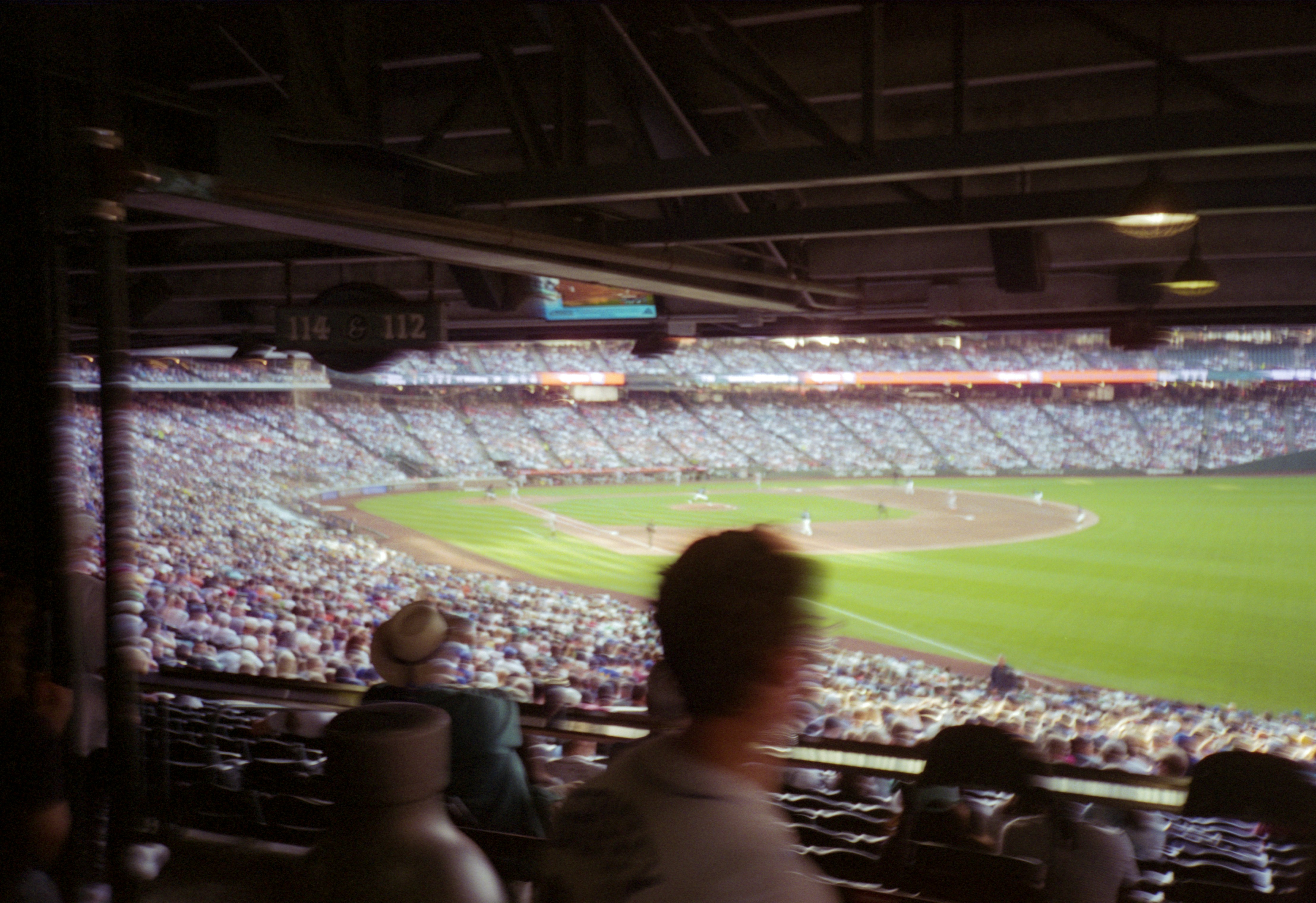 Spectators watch a baseball game in a stadium. photo – Free Film ...
