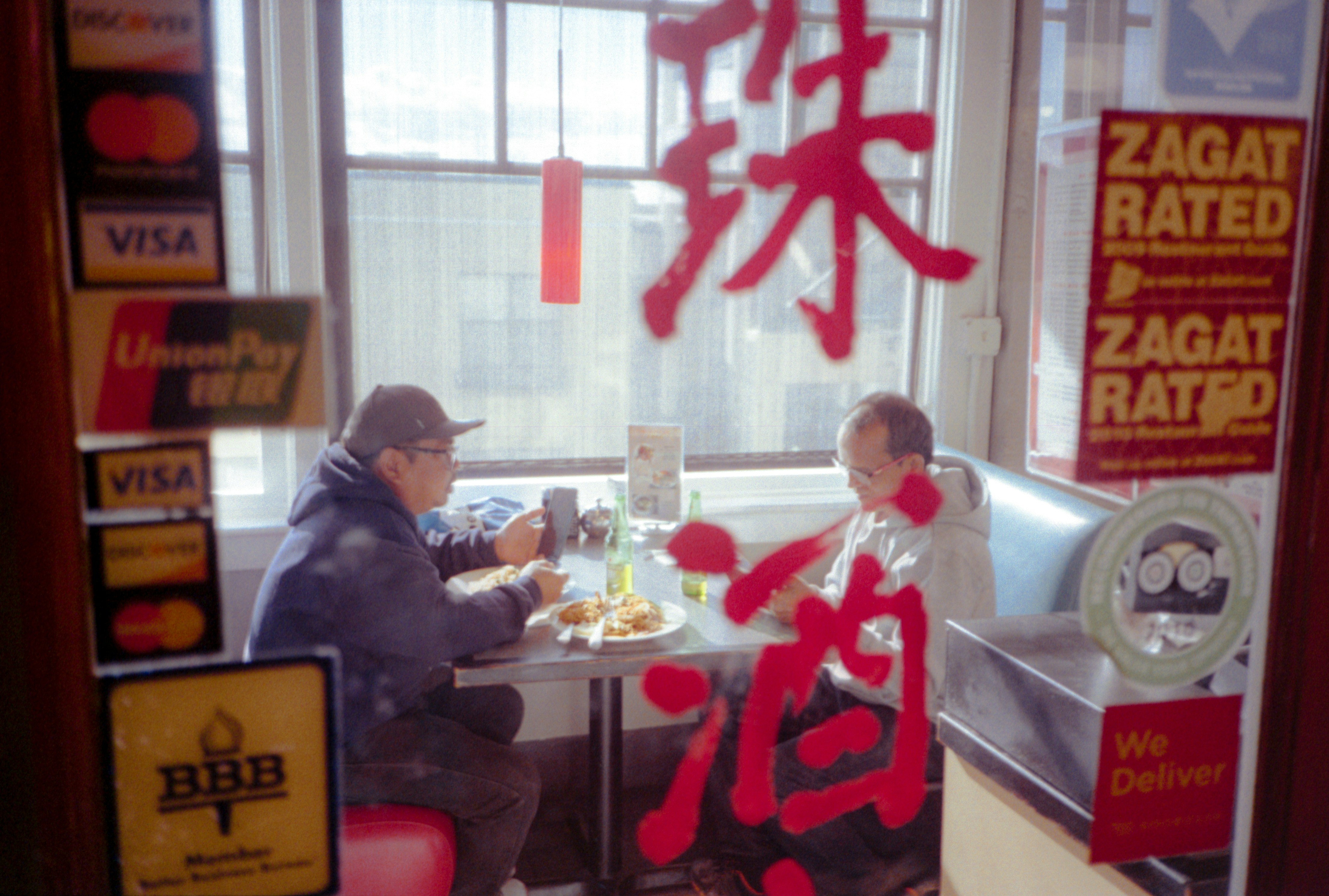 Two men are dining in a small, window-lit restaurant. photo – Free ...