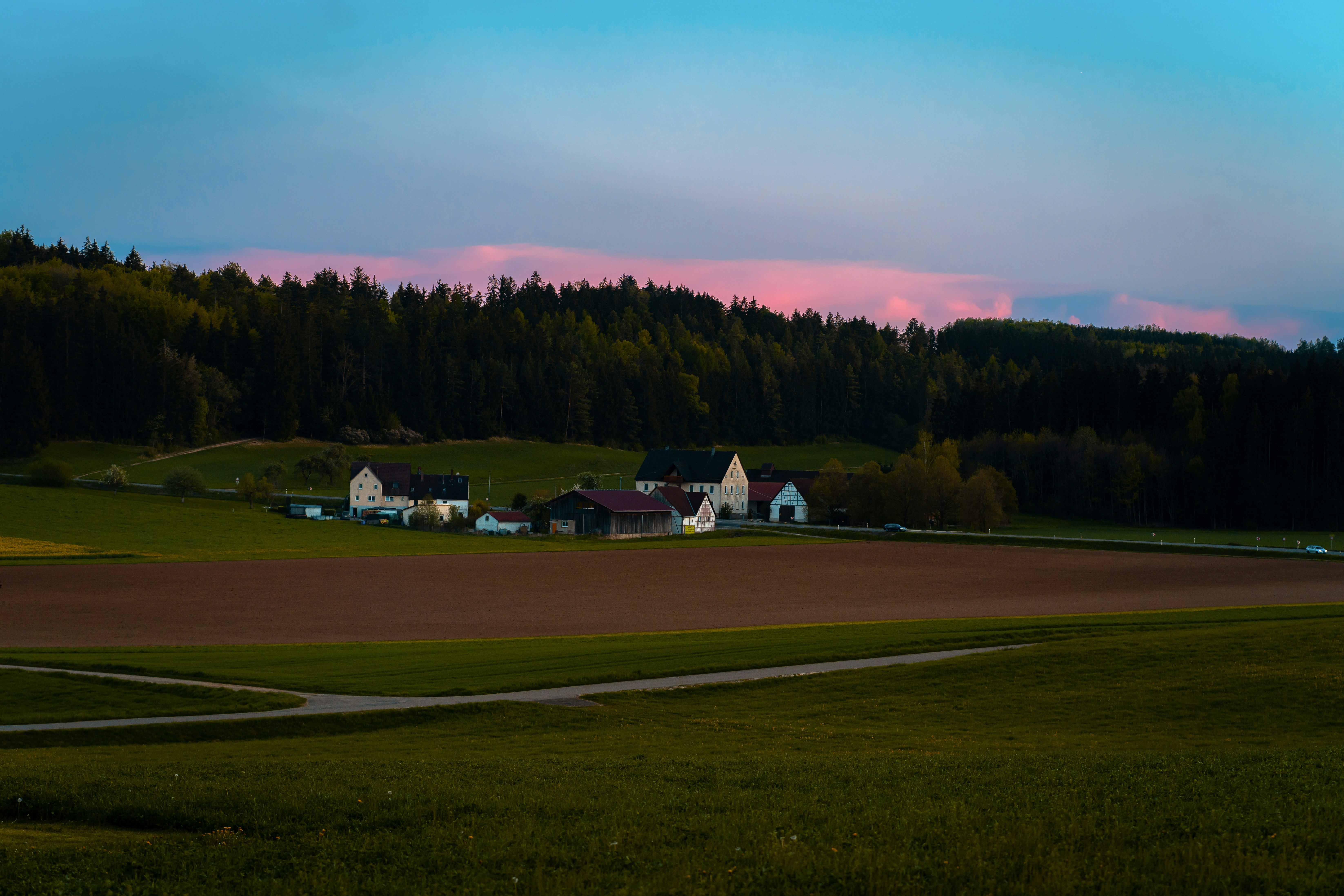 A farm is nestled in a field at dusk. photo – Free Wallpaper Image on ...