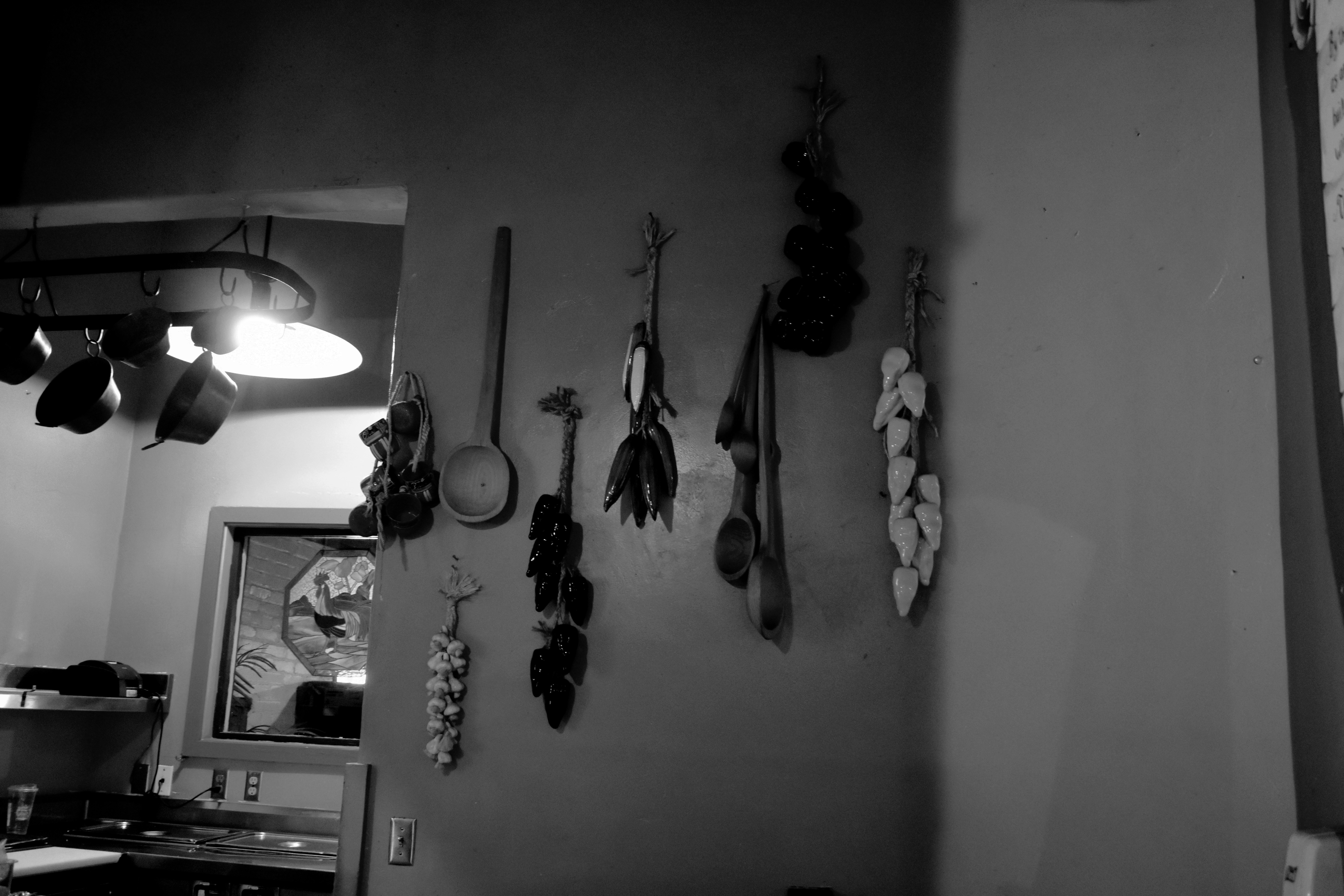 Kitchen wall decorations include hanging spices and utensils.