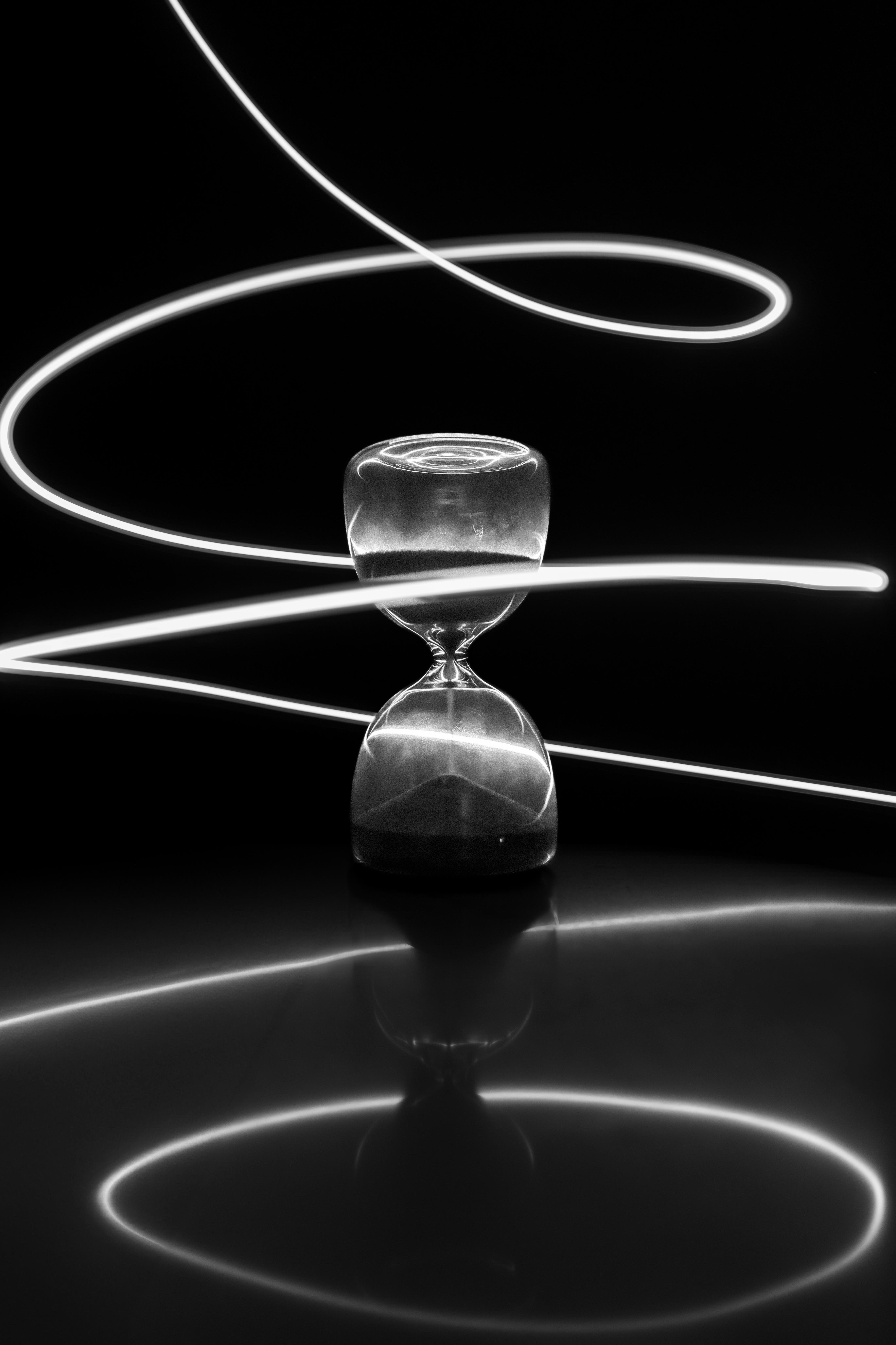 An hourglass and light trails reflect time. photo – Free Hourglass ...