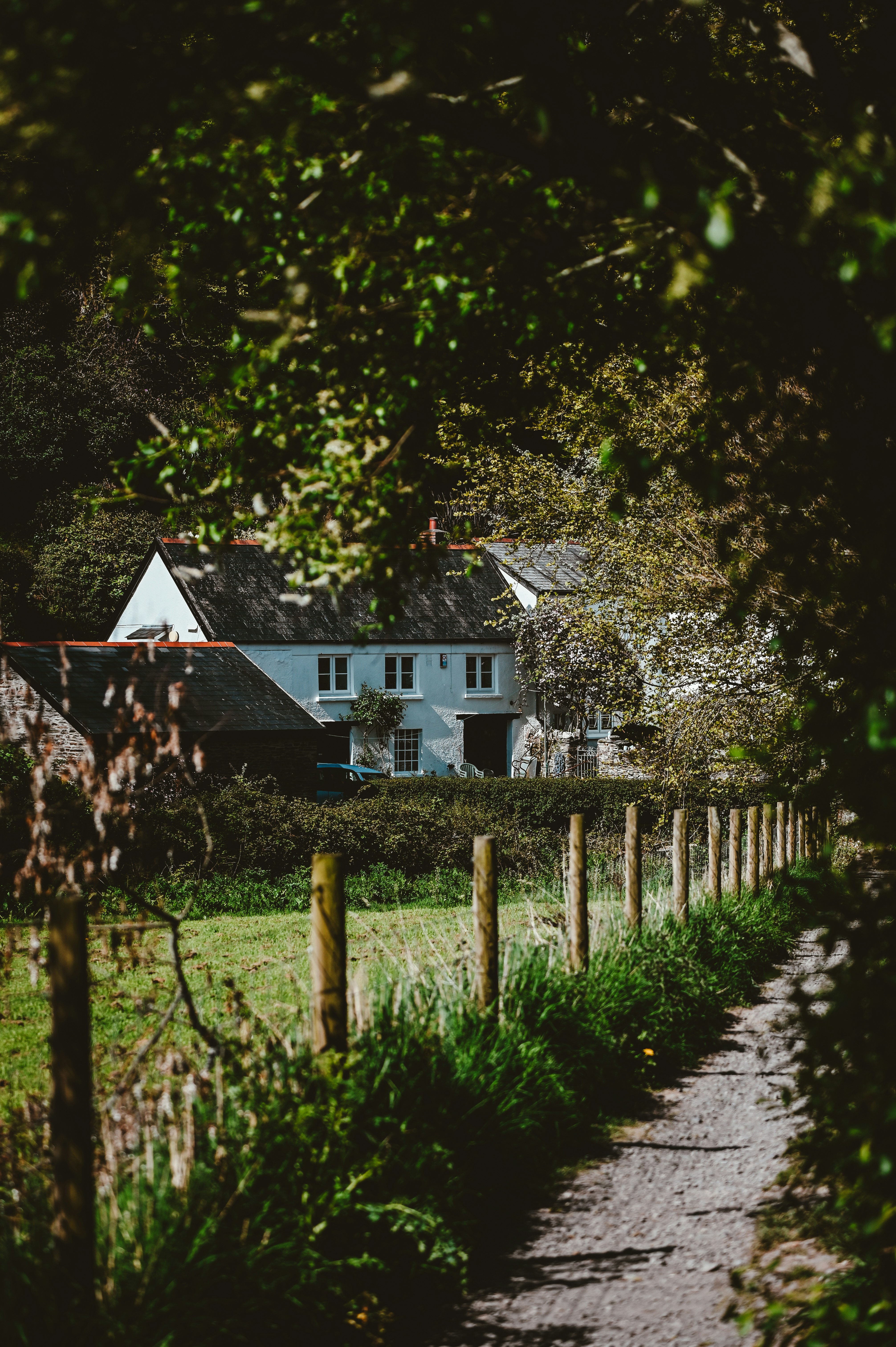 A quaint house sits behind a fence and path. photo – Free House Image ...