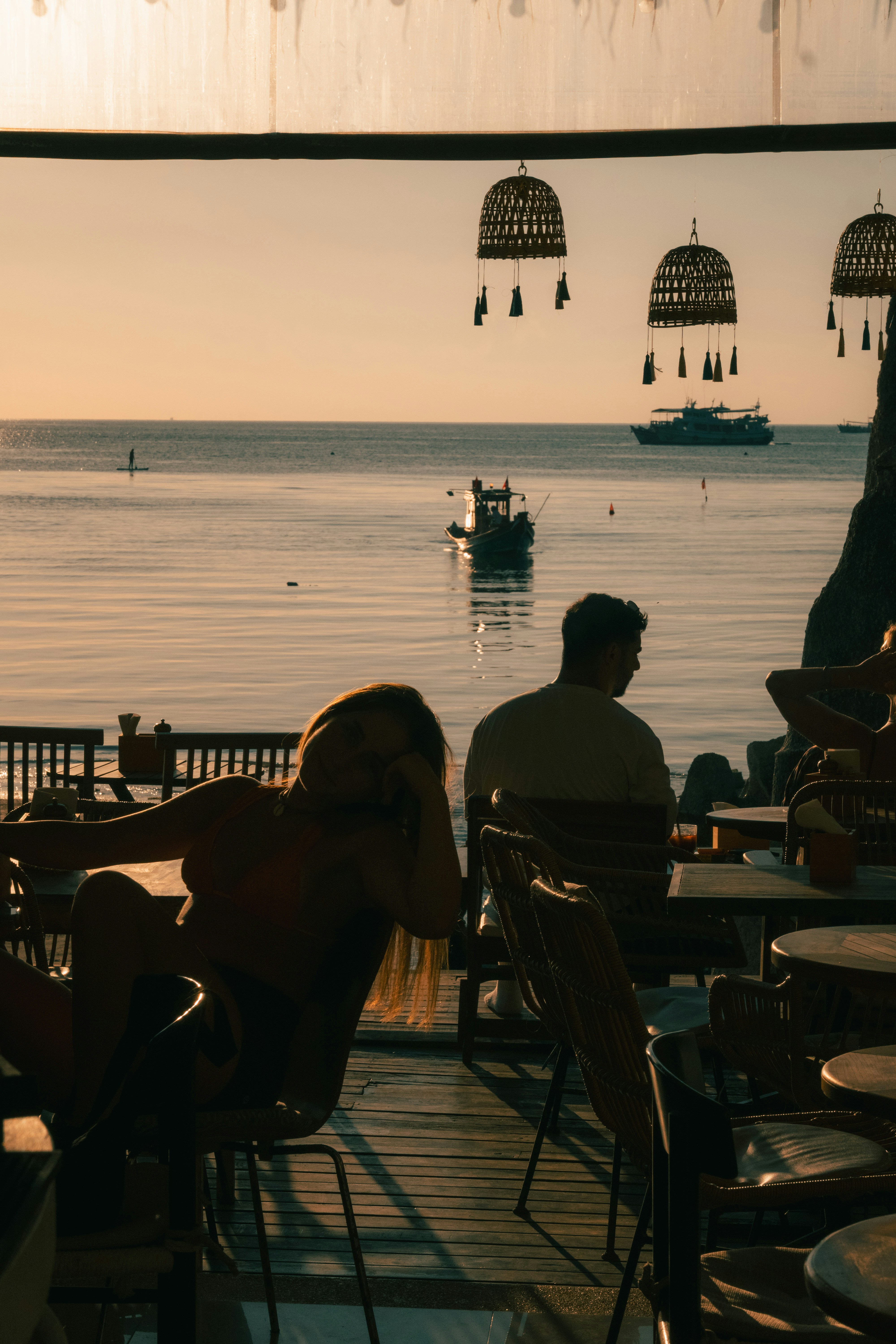 People relax and watch the sunset over the ocean. photo – Free Sea ...