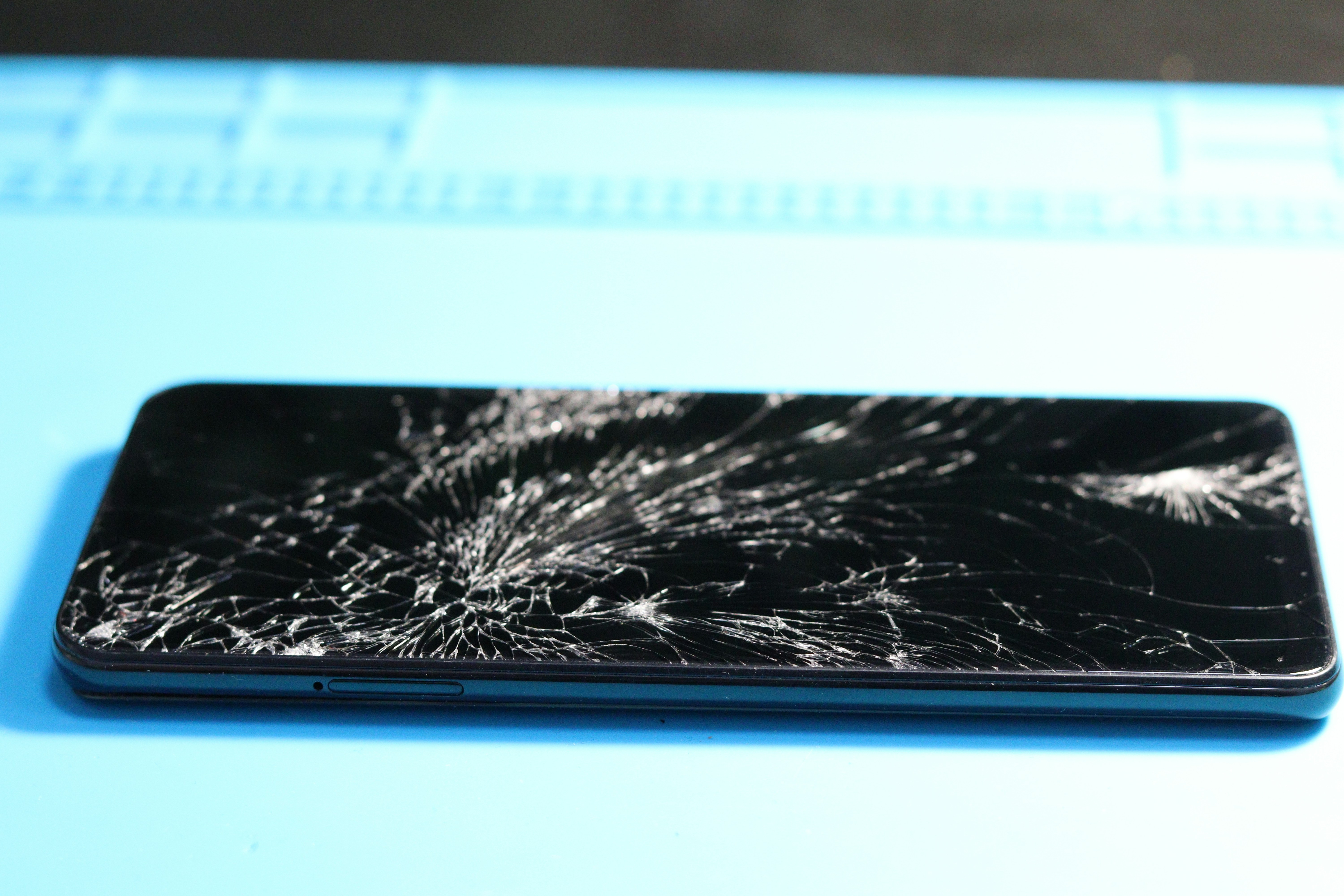 A smartphone with a shattered screen. photo – Free Cracked screen Image ...