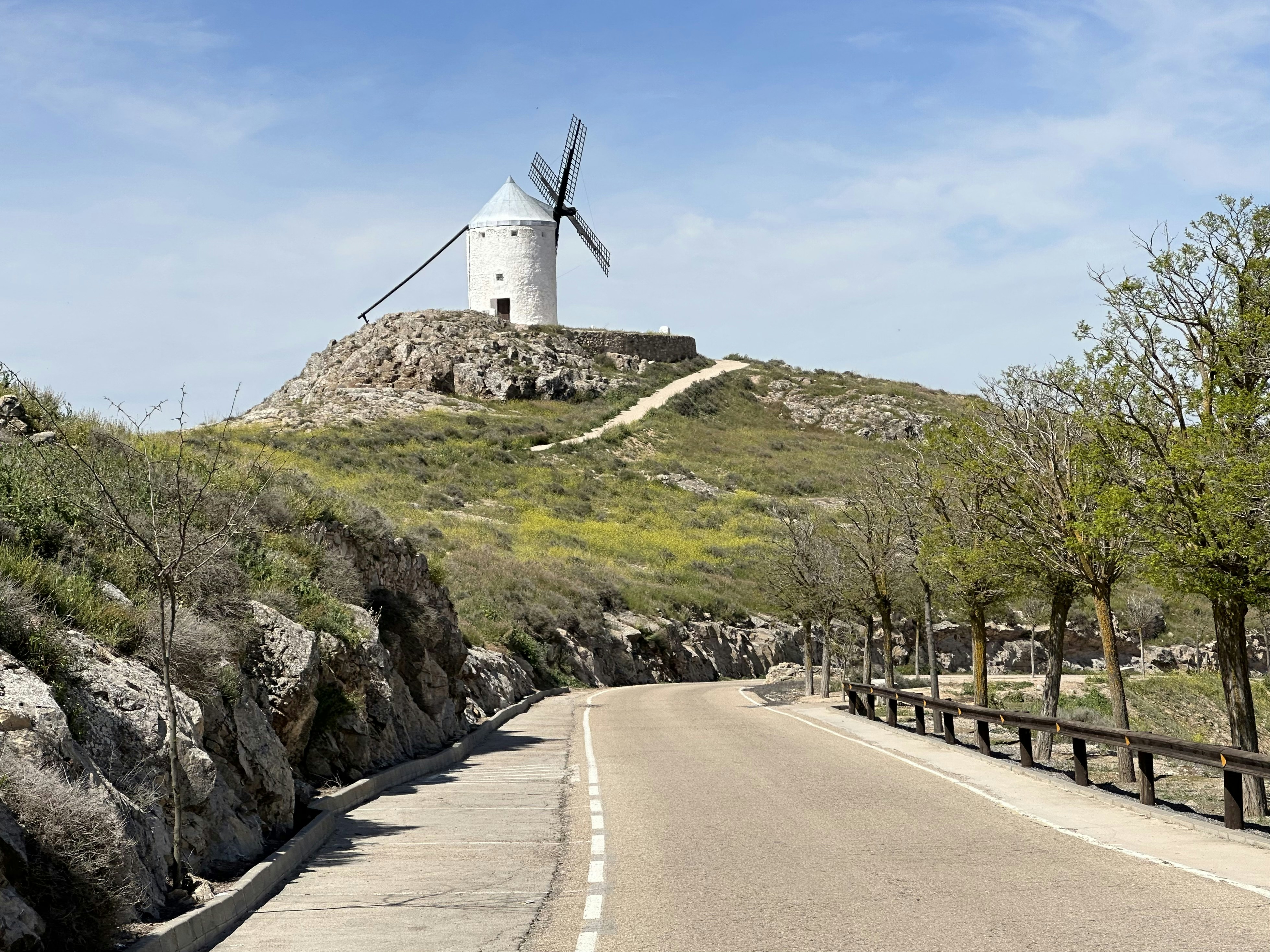 Hilltop Windmill Overlooking a Winding Road