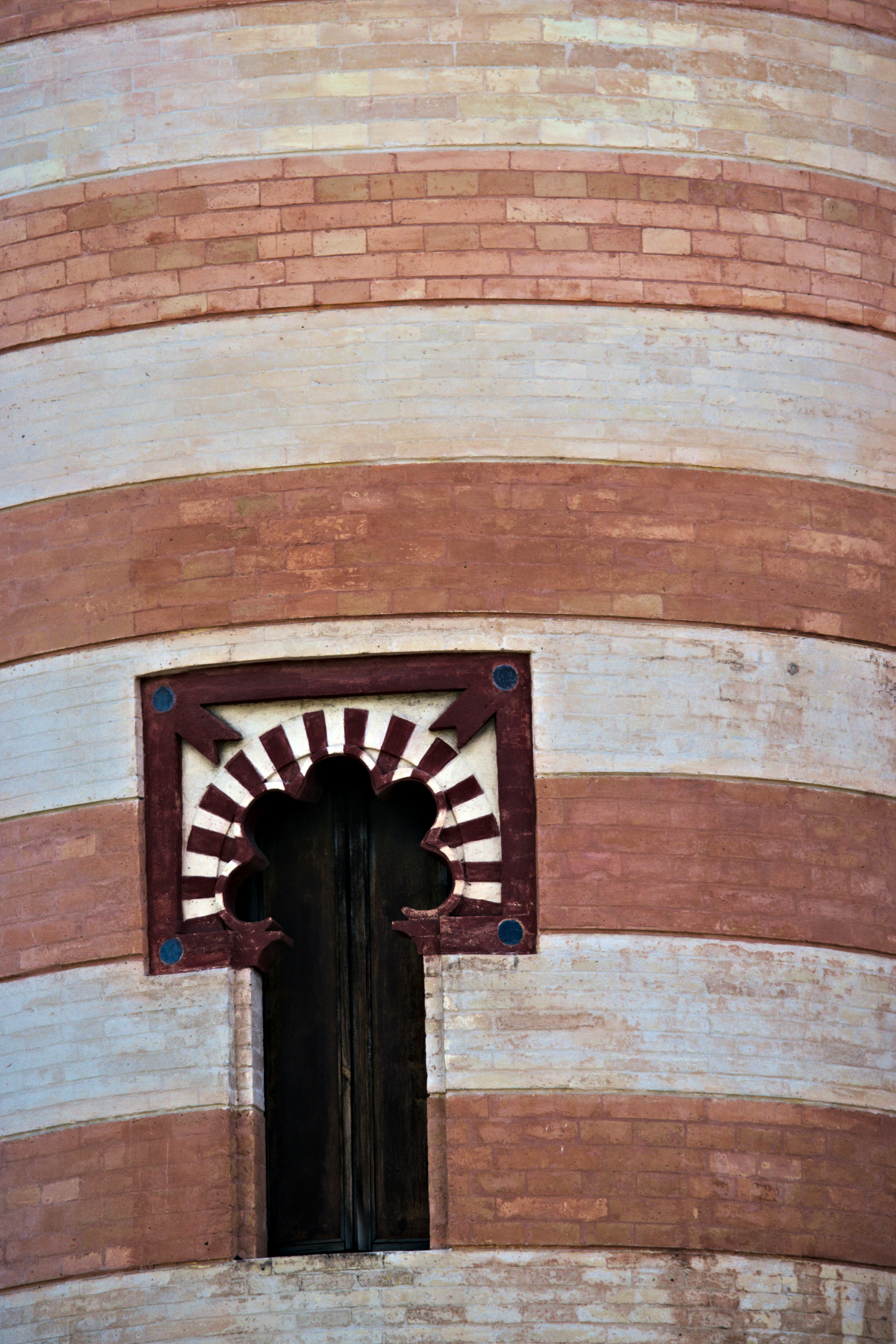 Sunburst Archway in a Striped Brick Tower