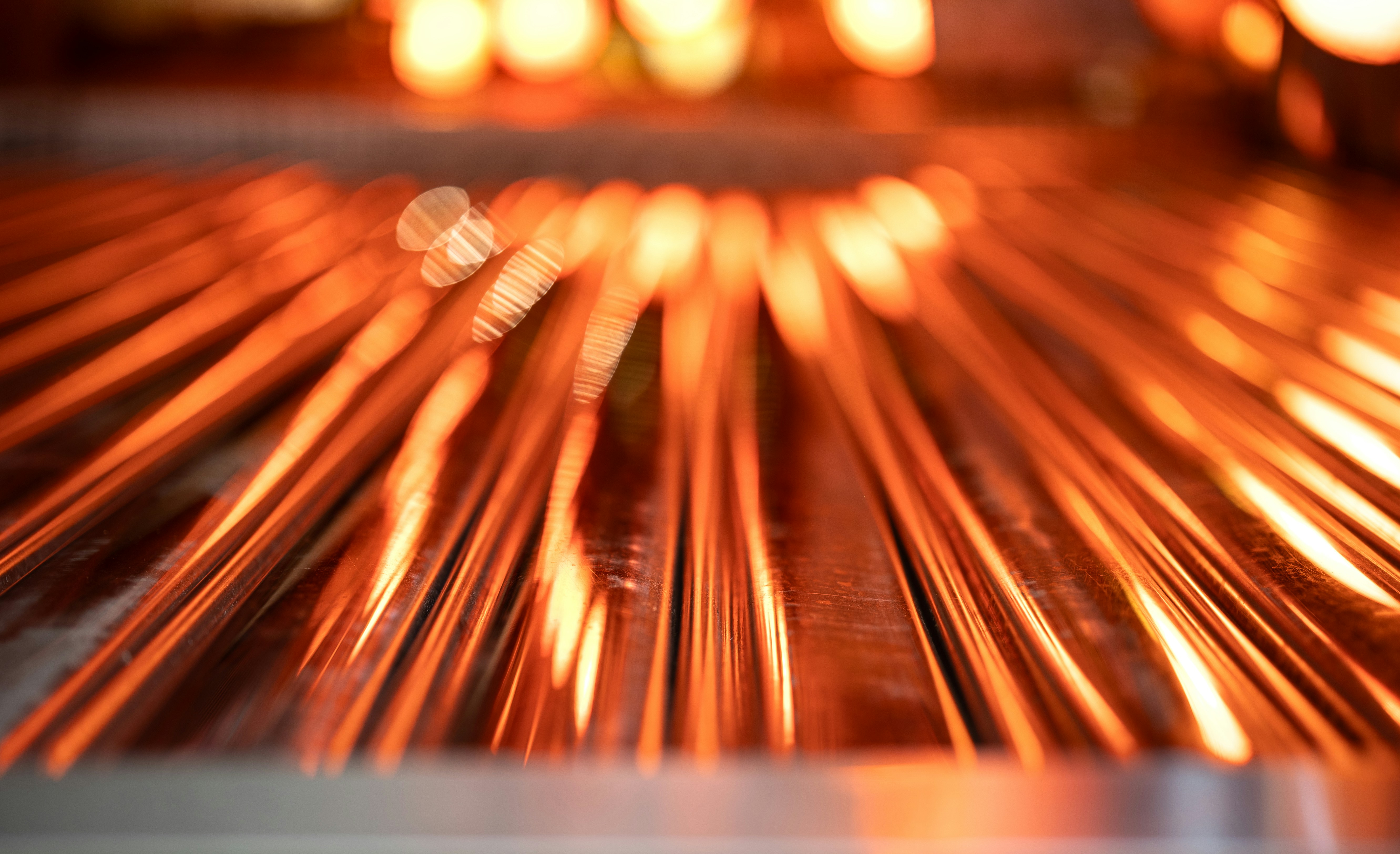 Glowing metal rods are shown inside a furnace. photo – Free Taiwan ...