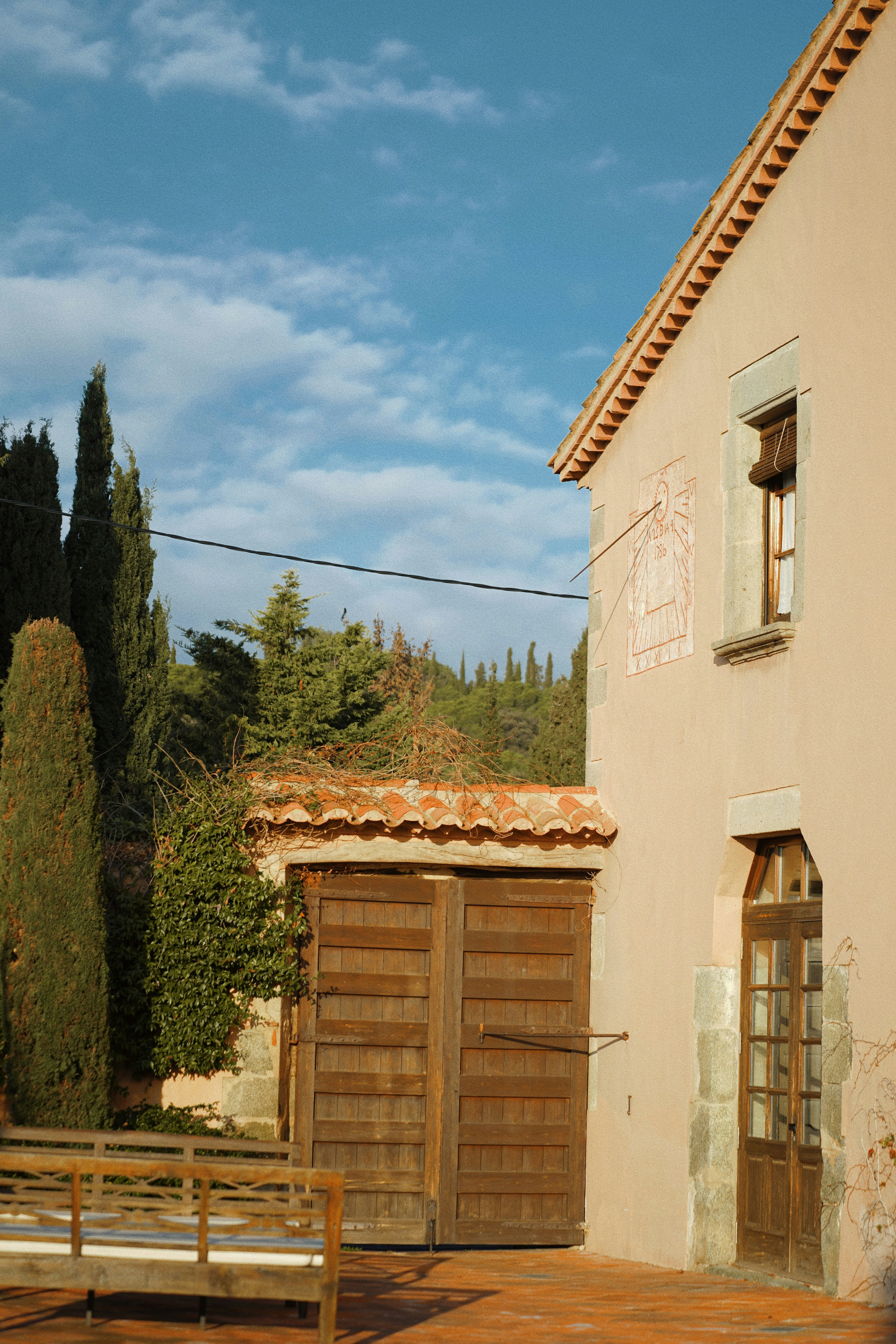 Weathered Doors, Terracotta Tiles, and a Sunlit Mediterranean Courtyard