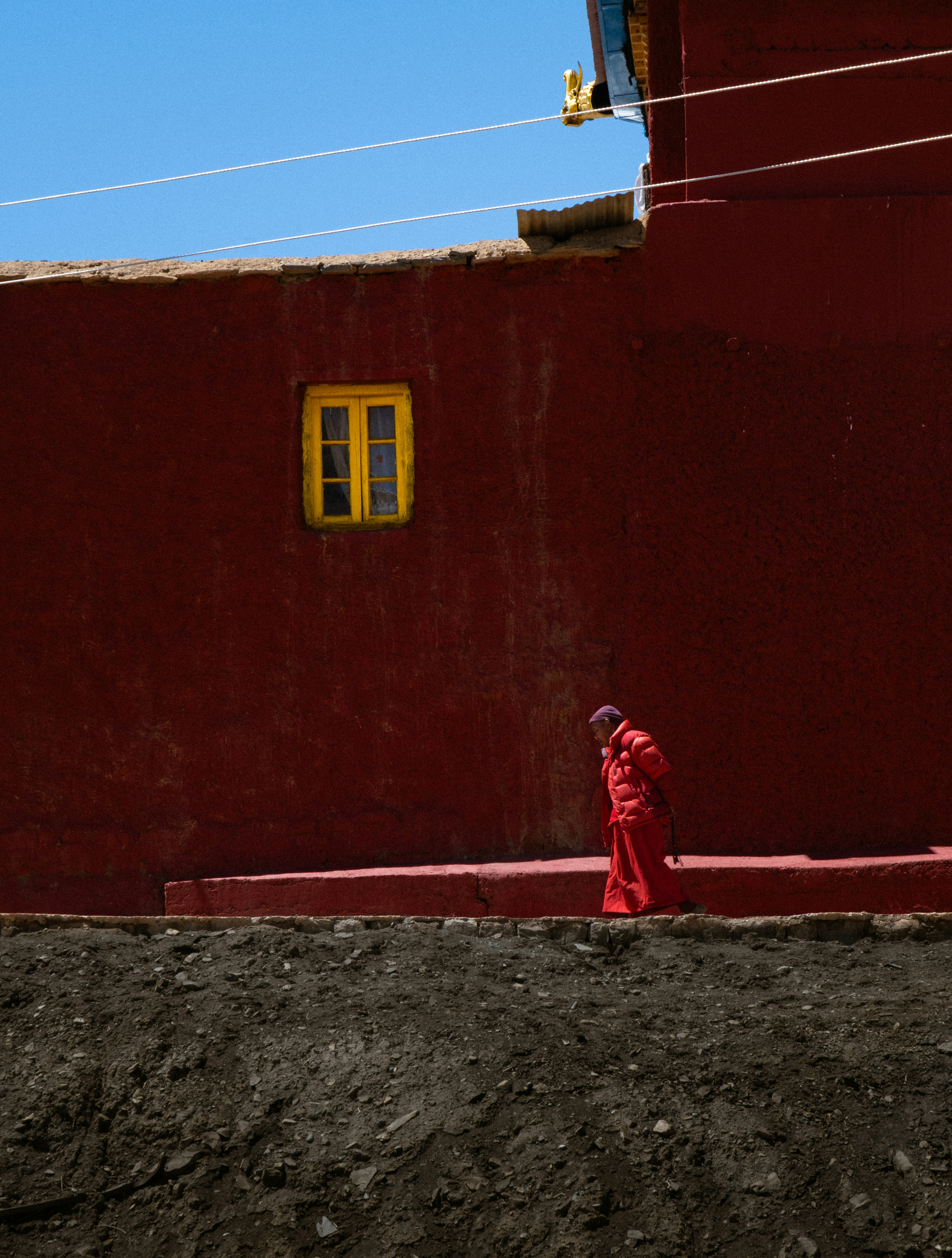 Monk in red walks near a red wall. photo – Free Meditation Image on ...
